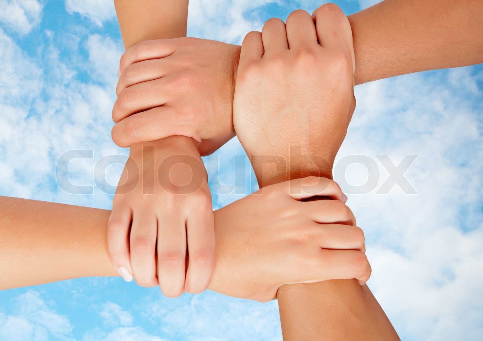 Joined hands in a symbol of cooperation | Stock image | Colourbox