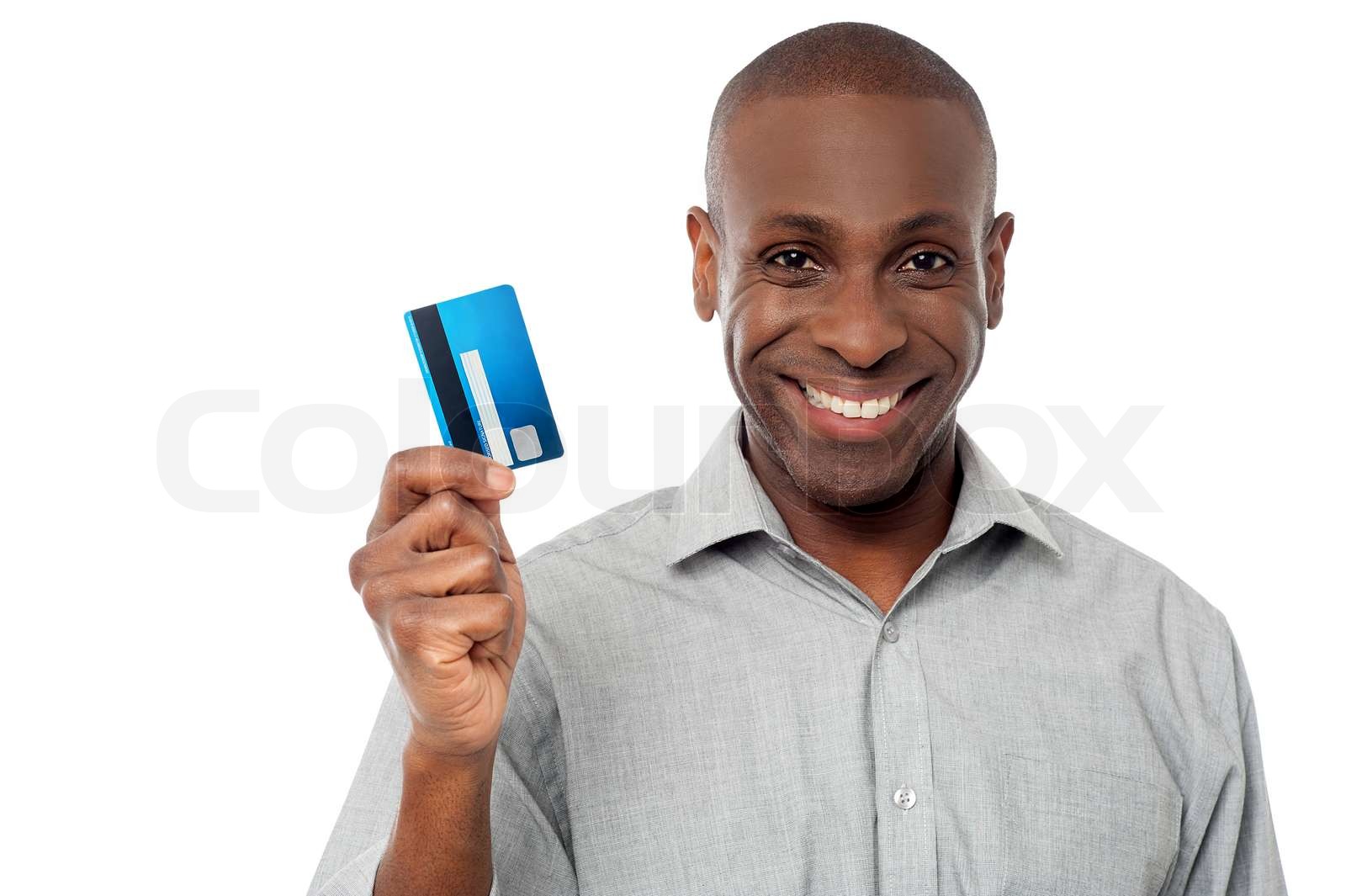 Smiling guy holding credit card | Stock image | Colourbox