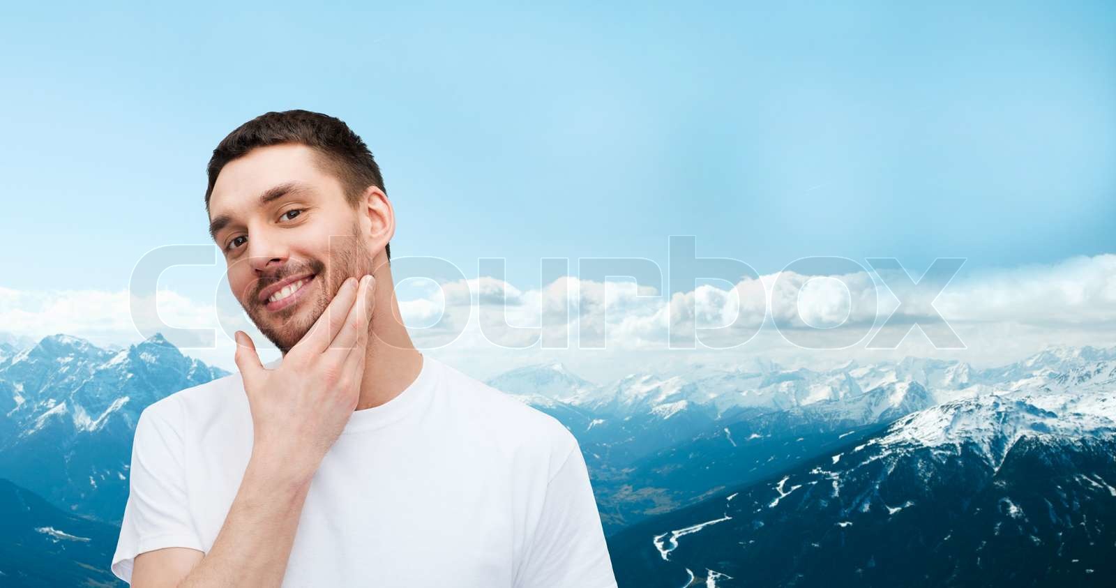 beautiful smiling man touching his face | Stock image | Colourbox