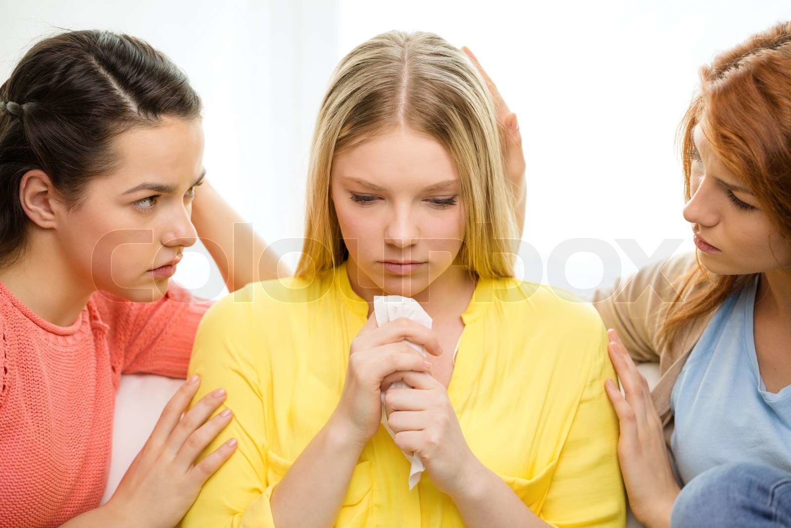two teenage girls comforting another after breakup | Stock image ...