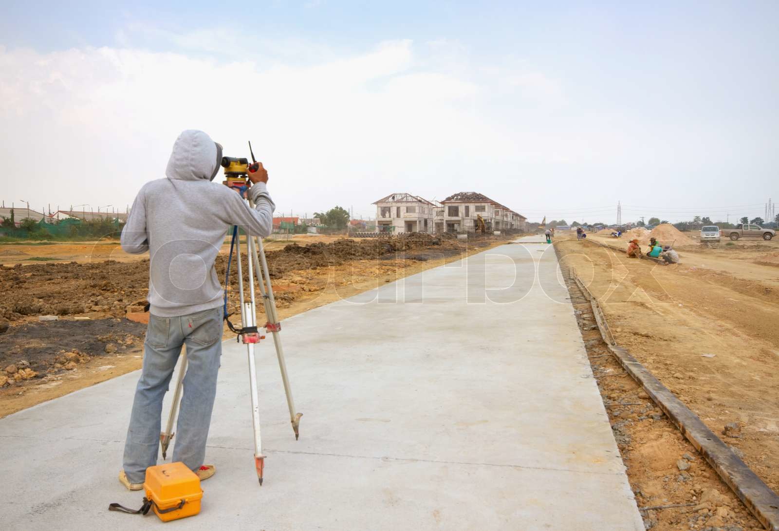 Surveyor engineer making measure on the road | Stock image | Colourbox