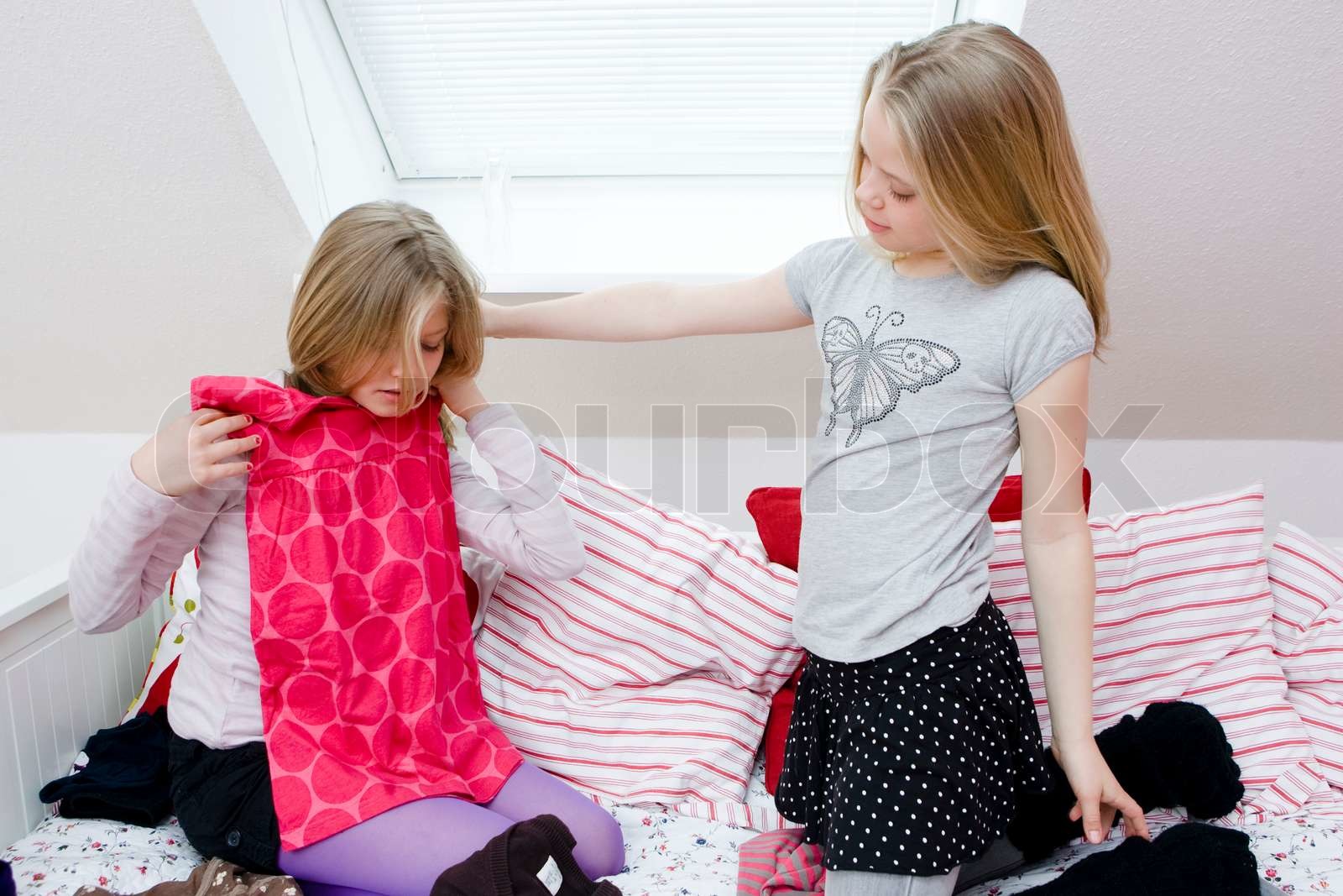 Two teenage girls checking out new clothes | Stock image | Colourbox
