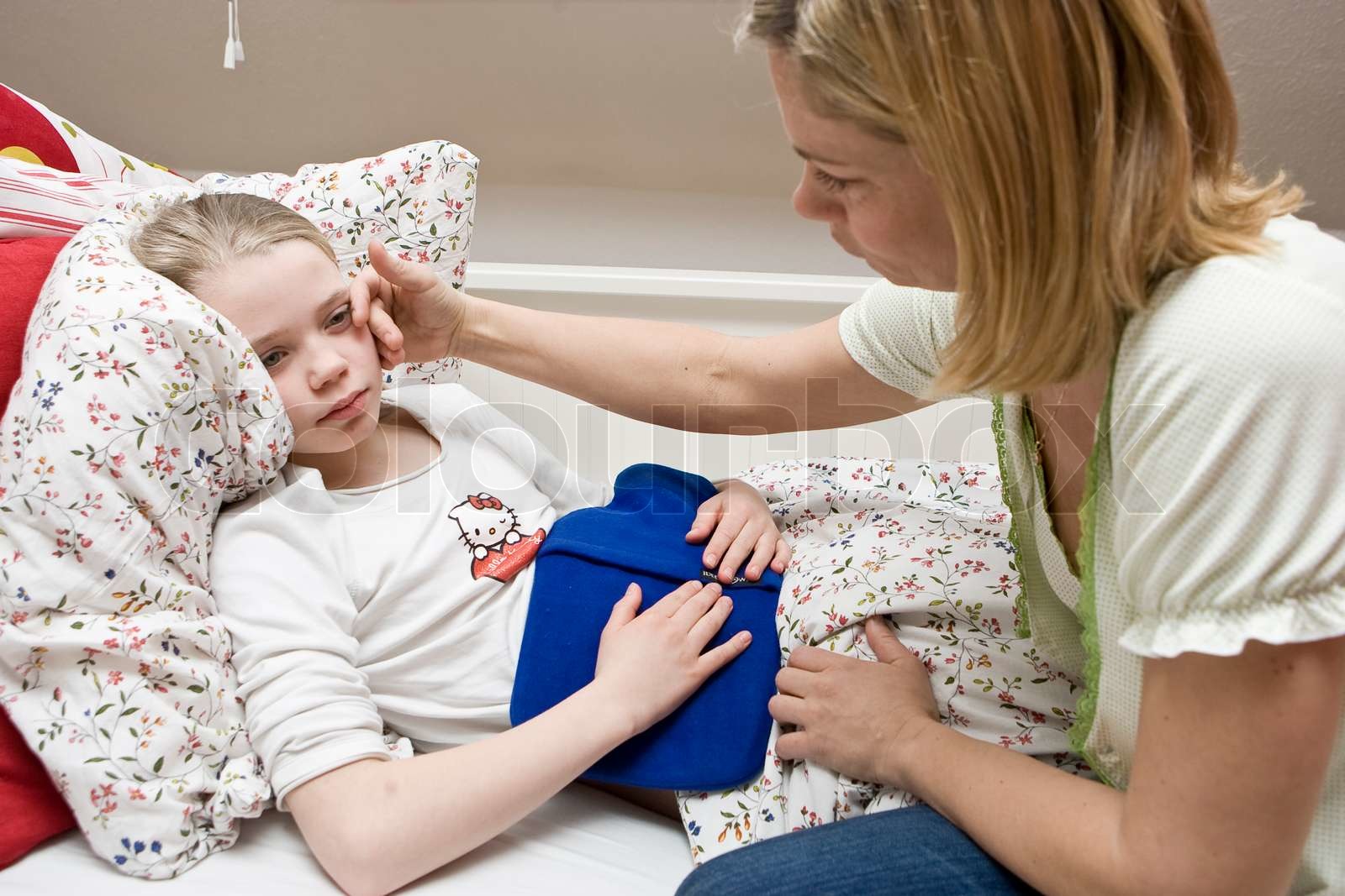 A mother comforting her sick daughter | Stock image | Colourbox