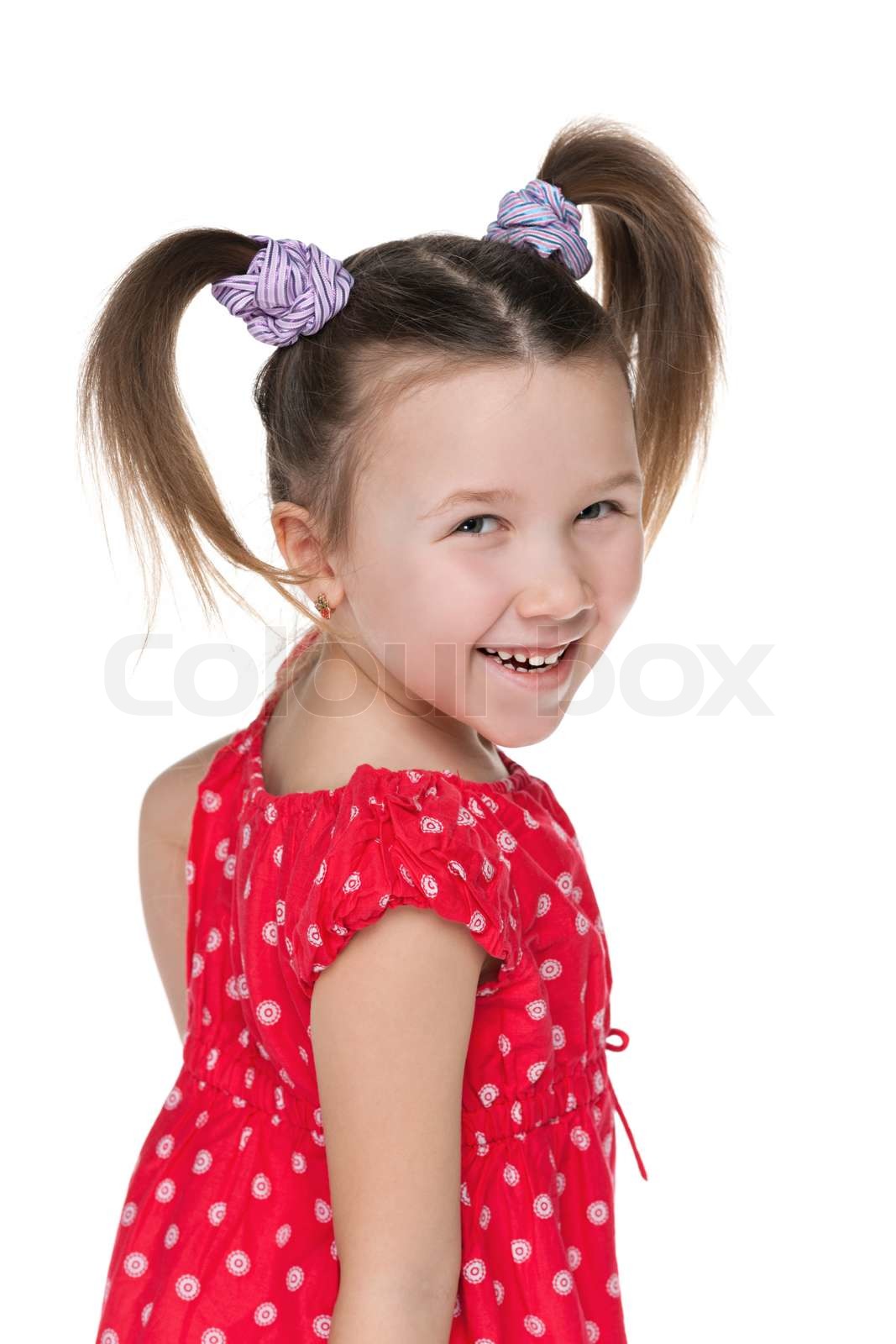 Happy little girl looks back | Stock image | Colourbox