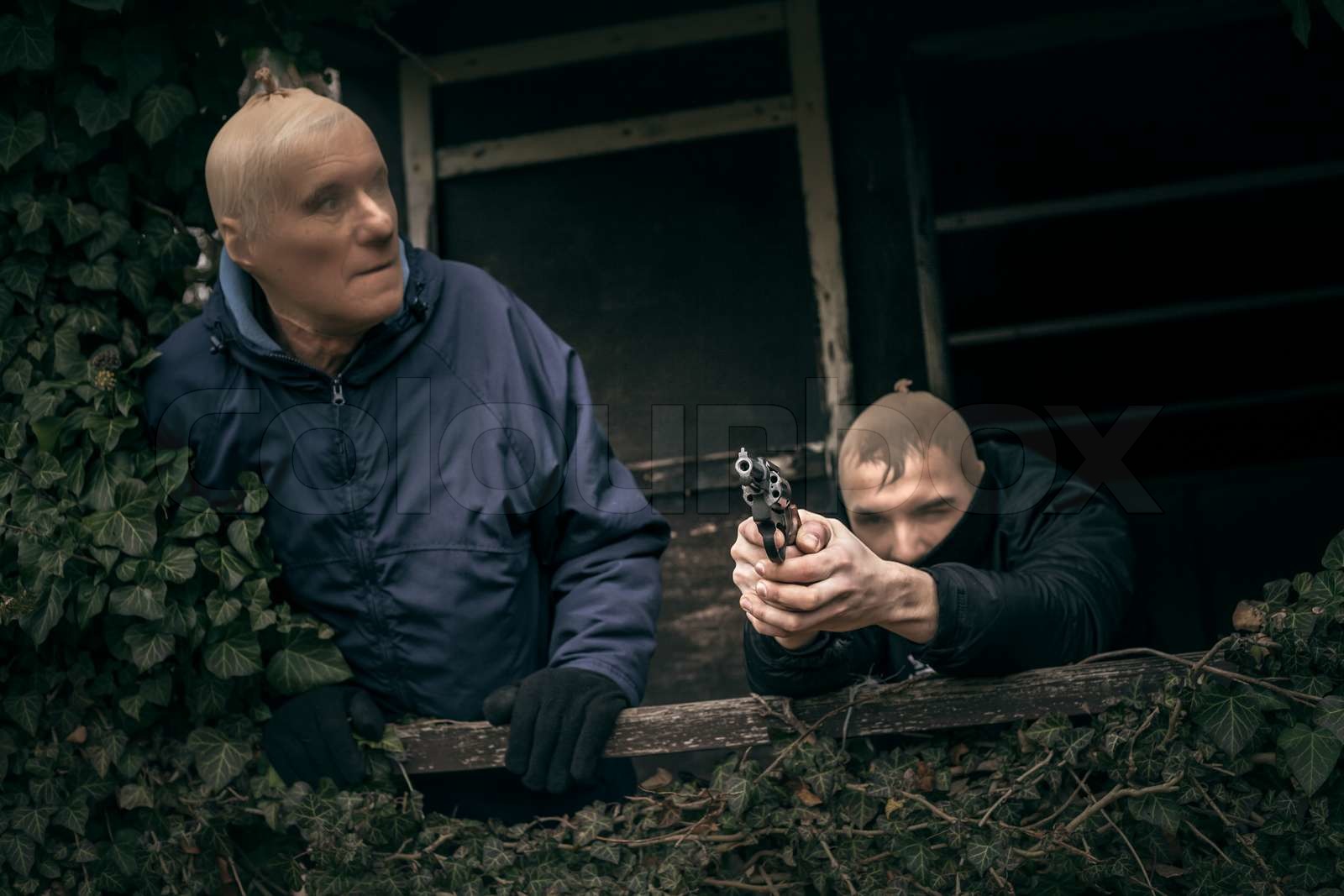Masked men with a gun | Stock image | Colourbox