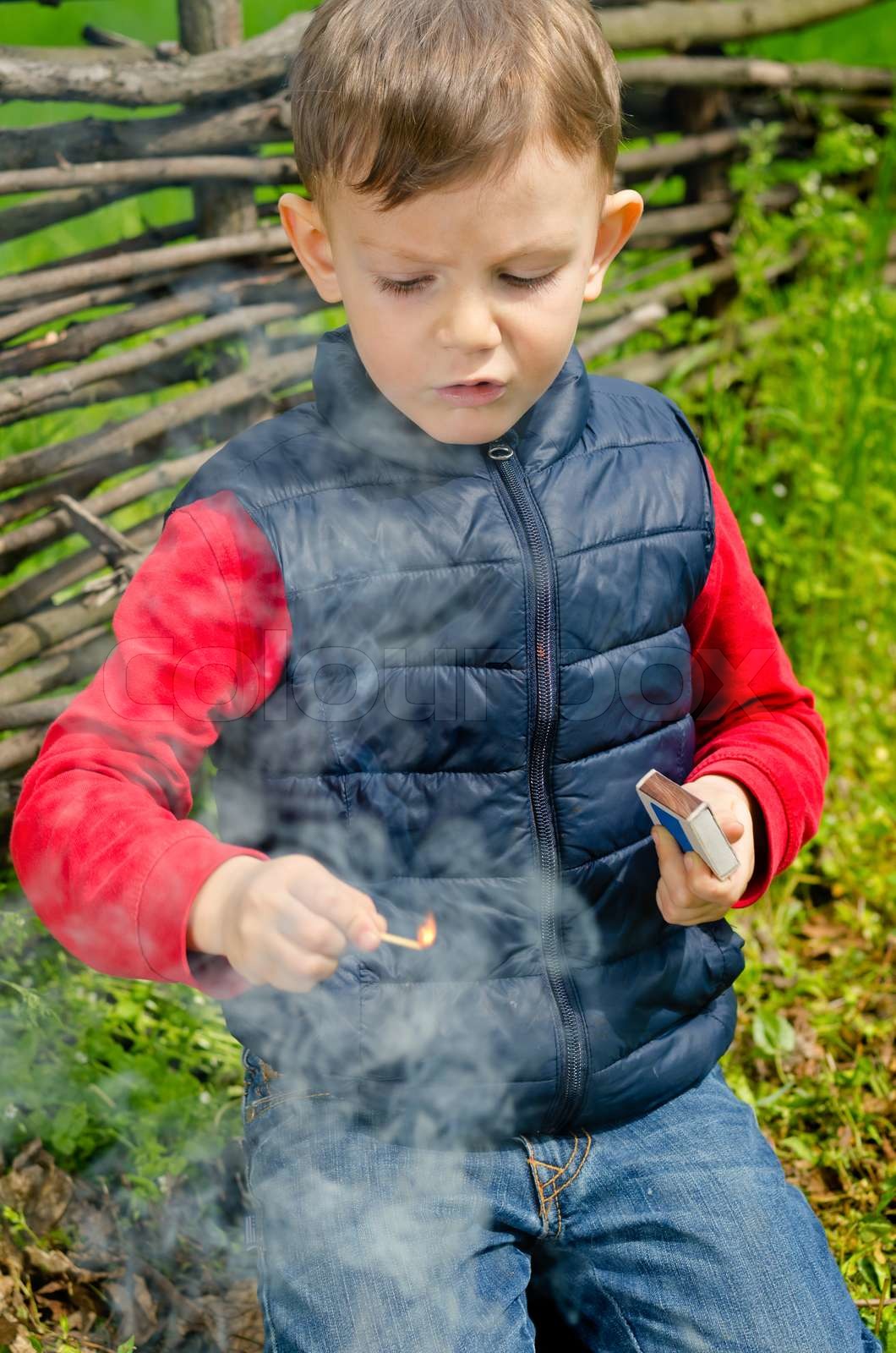 Child striking a match | Stock image | Colourbox
