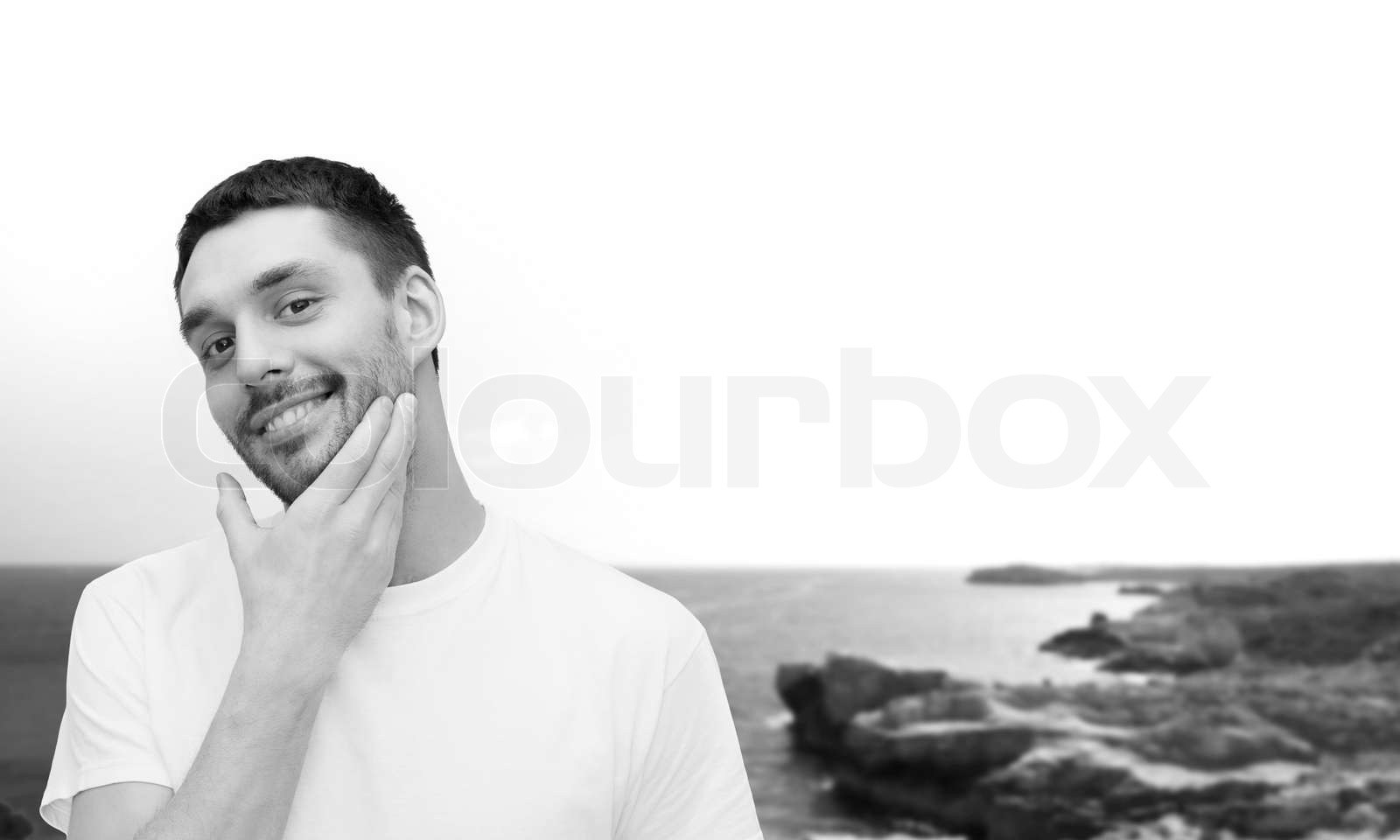 beautiful smiling man touching his face | Stock image | Colourbox