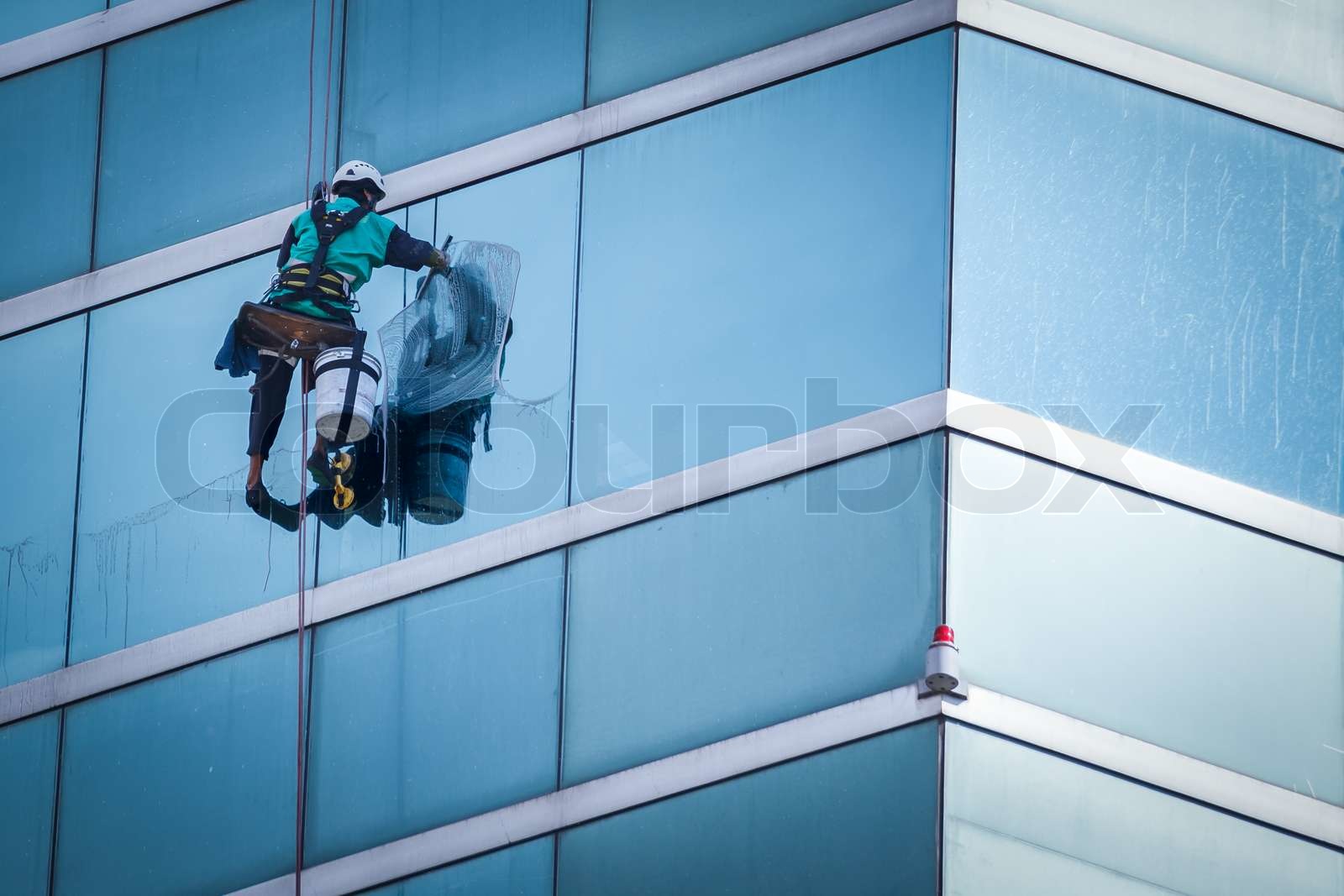 group of workers cleaning windows service on high rise building | Stock ...