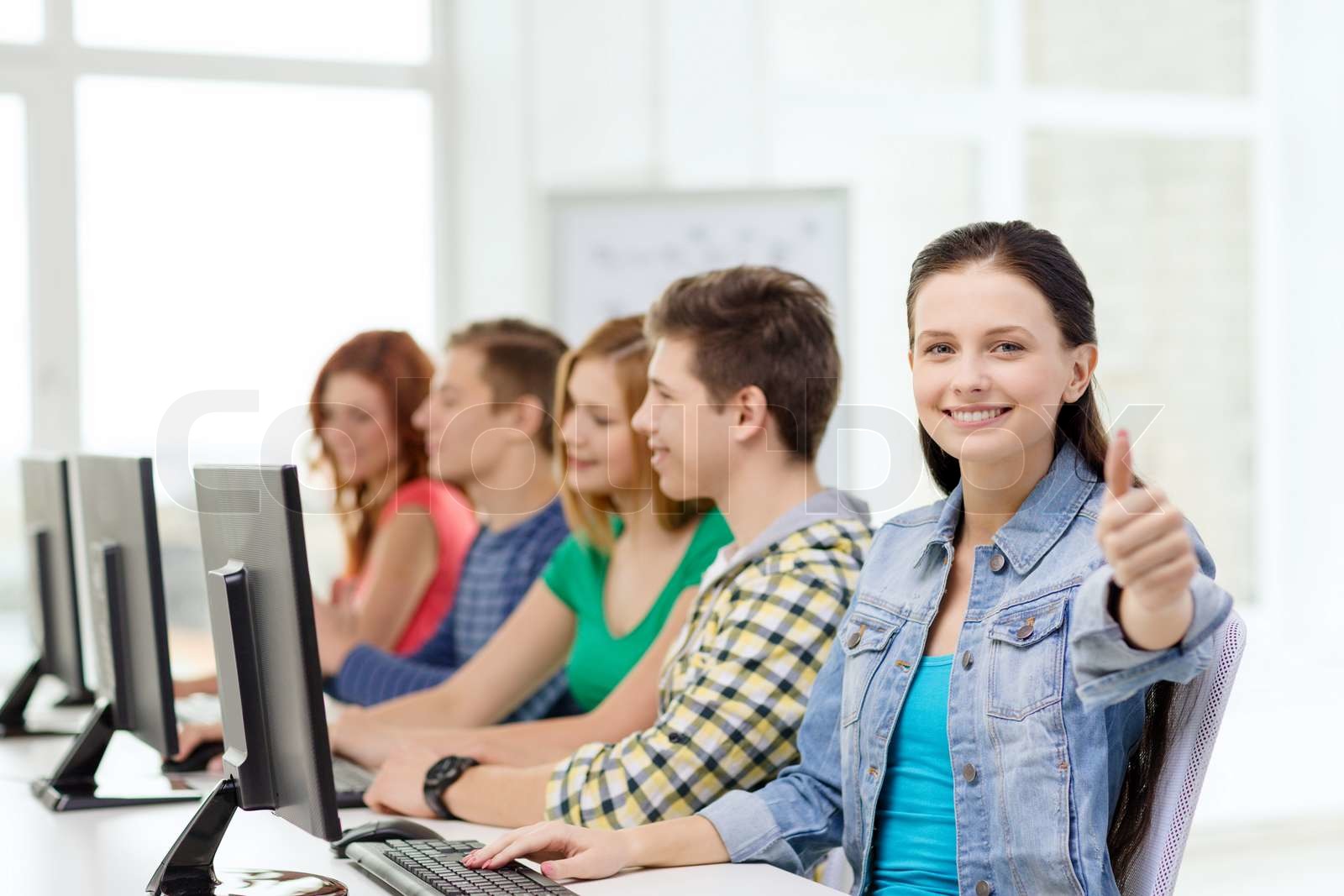 female student with classmates in computer class | Stock image | Colourbox