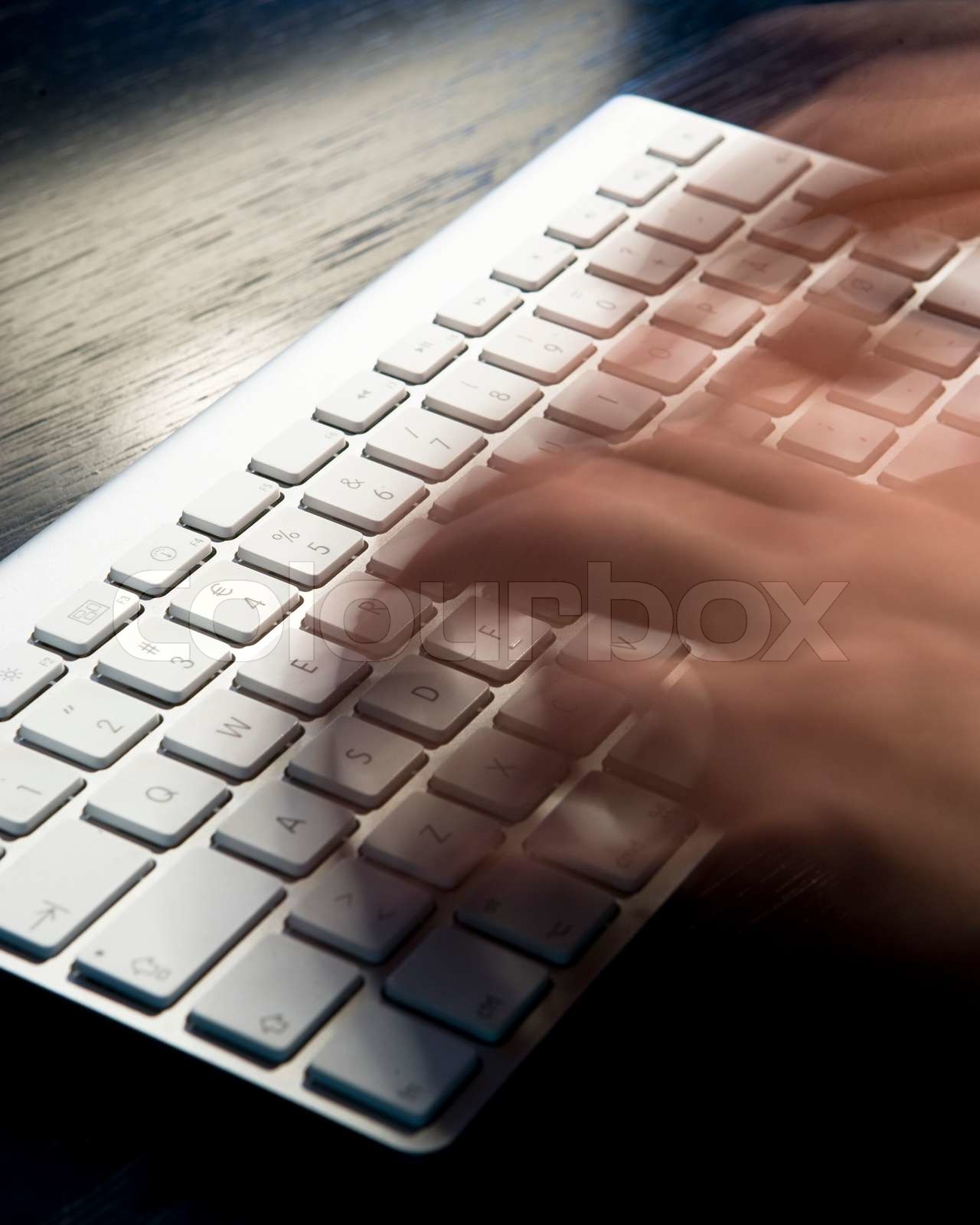 Blurred image of hands on computer keyboard | Stock image | Colourbox