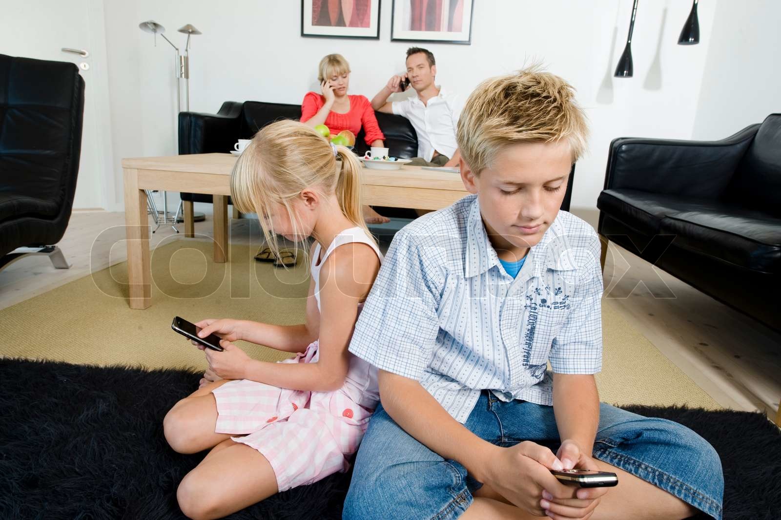 Family members with a cellphone for each one | Stock image | Colourbox