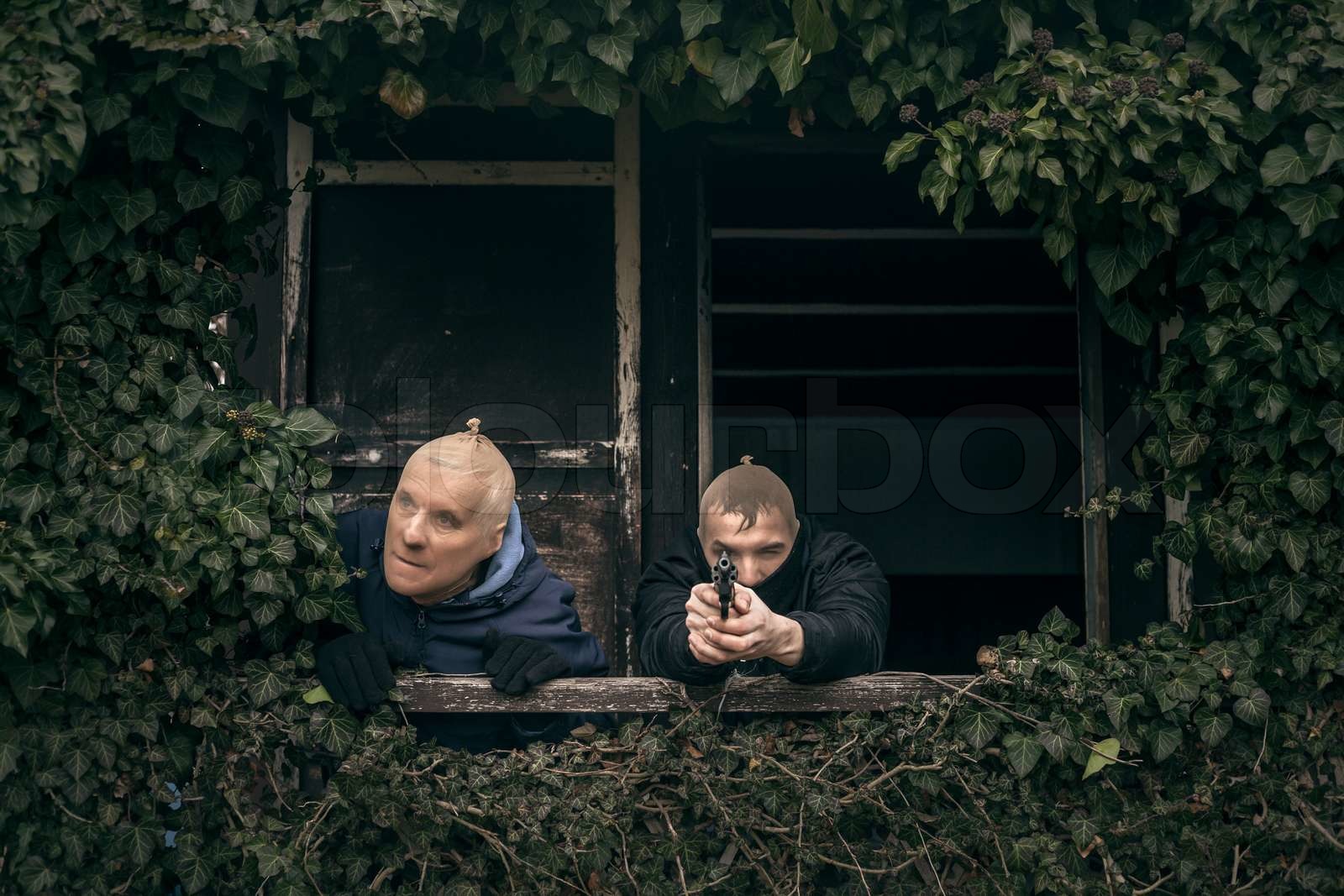 Masked men with a gun | Stock image | Colourbox