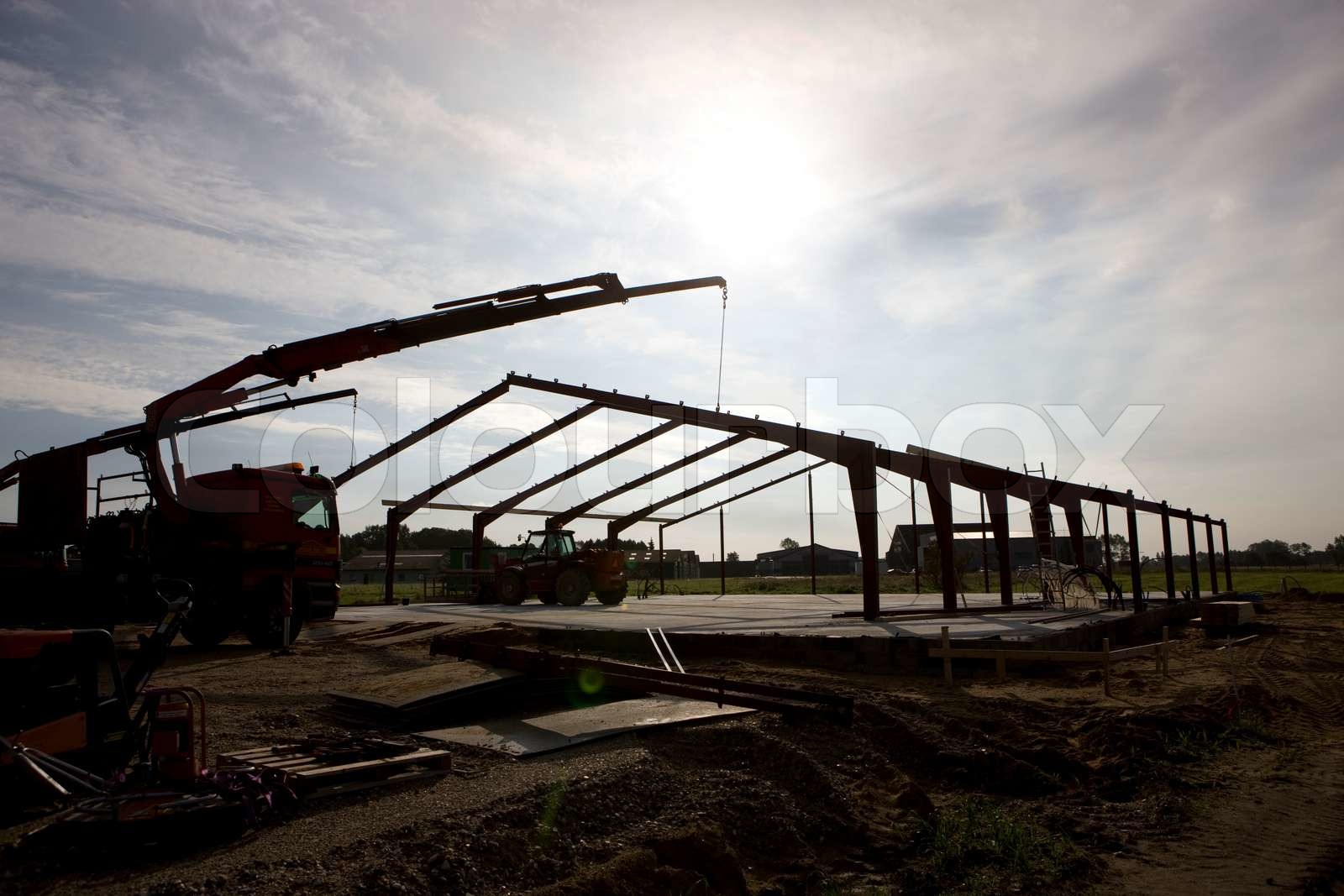 Crane carrying a metal beam | Stock image | Colourbox