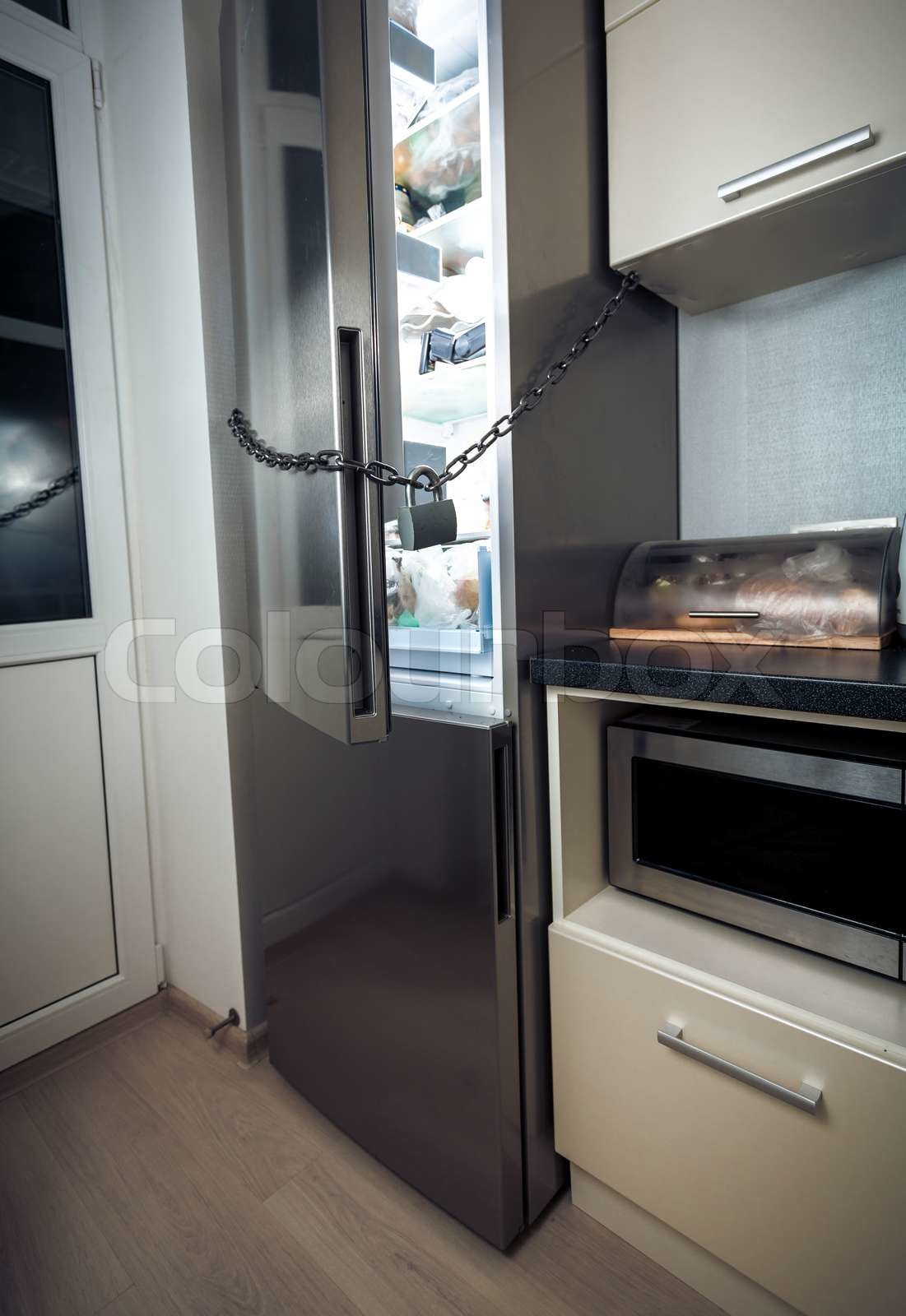 refrigerator on kitchen locked by chain | Stock image | Colourbox