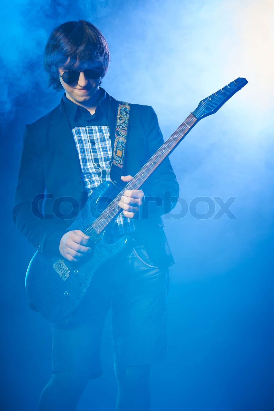 Young guitarist performing on stage | Stock image | Colourbox