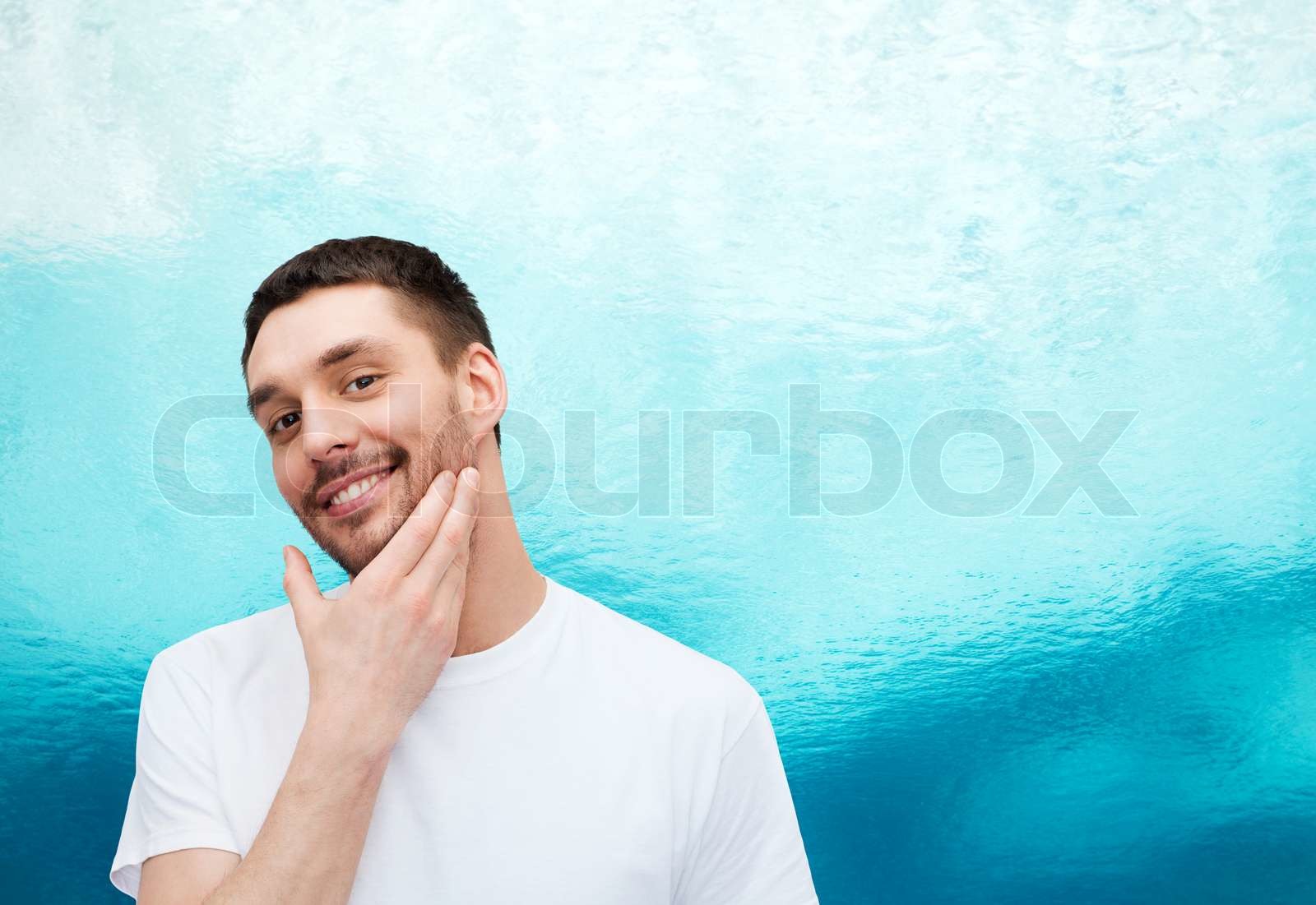 beautiful smiling man touching his face | Stock image | Colourbox