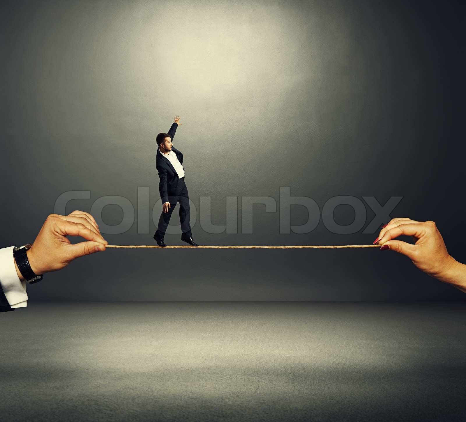 man balancing on the rope over dark | Stock image | Colourbox