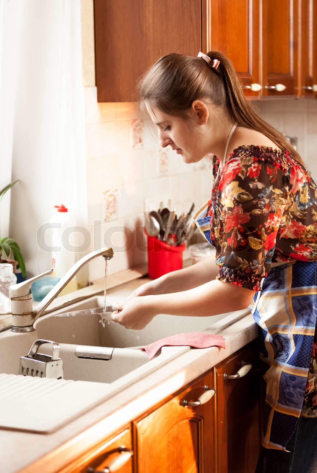 portrait of woman washing dishes on kitchen | Stock image | Colourbox