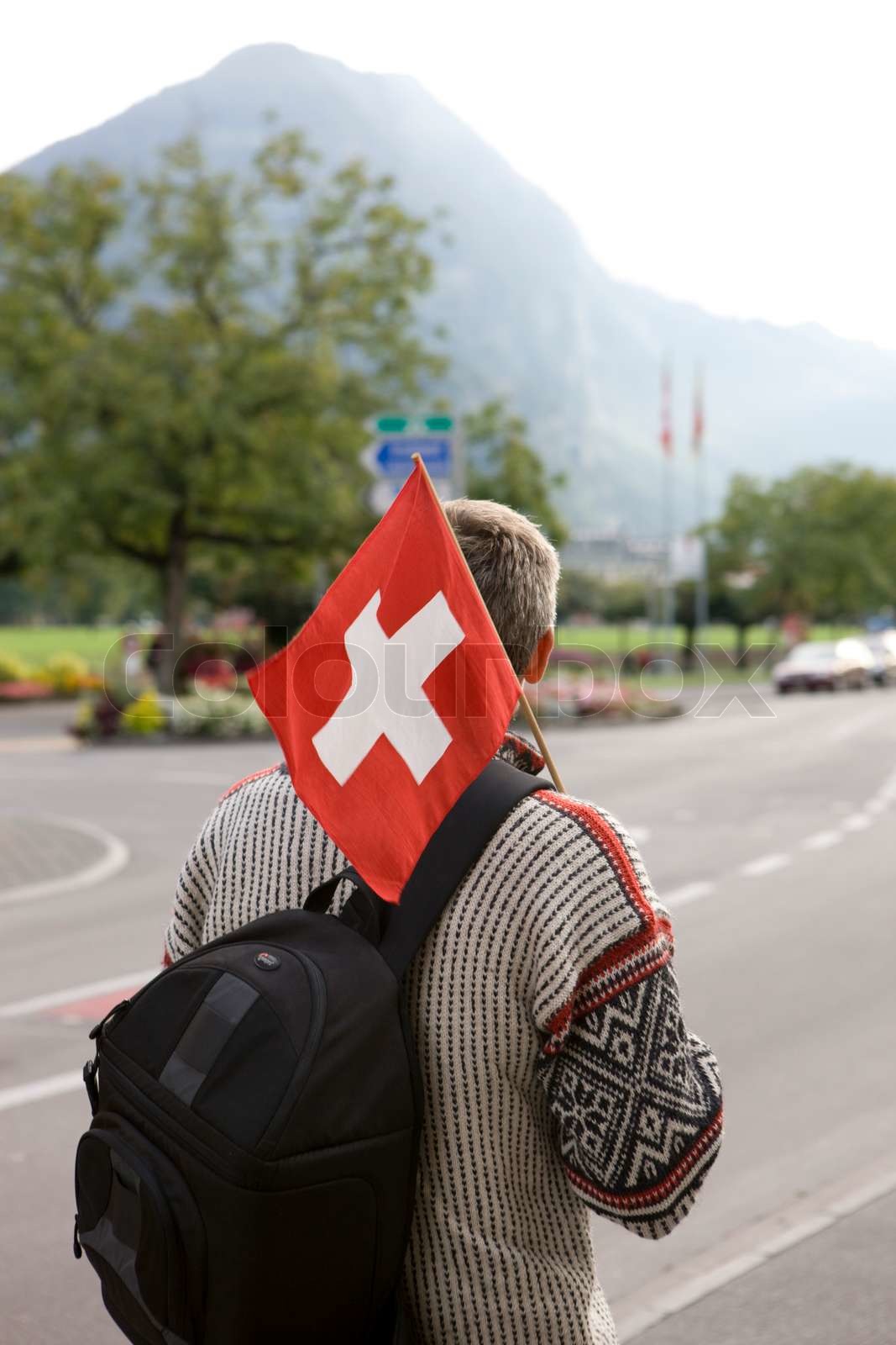 A man with a Swiss flag in Interlaken | Stock image | Colourbox