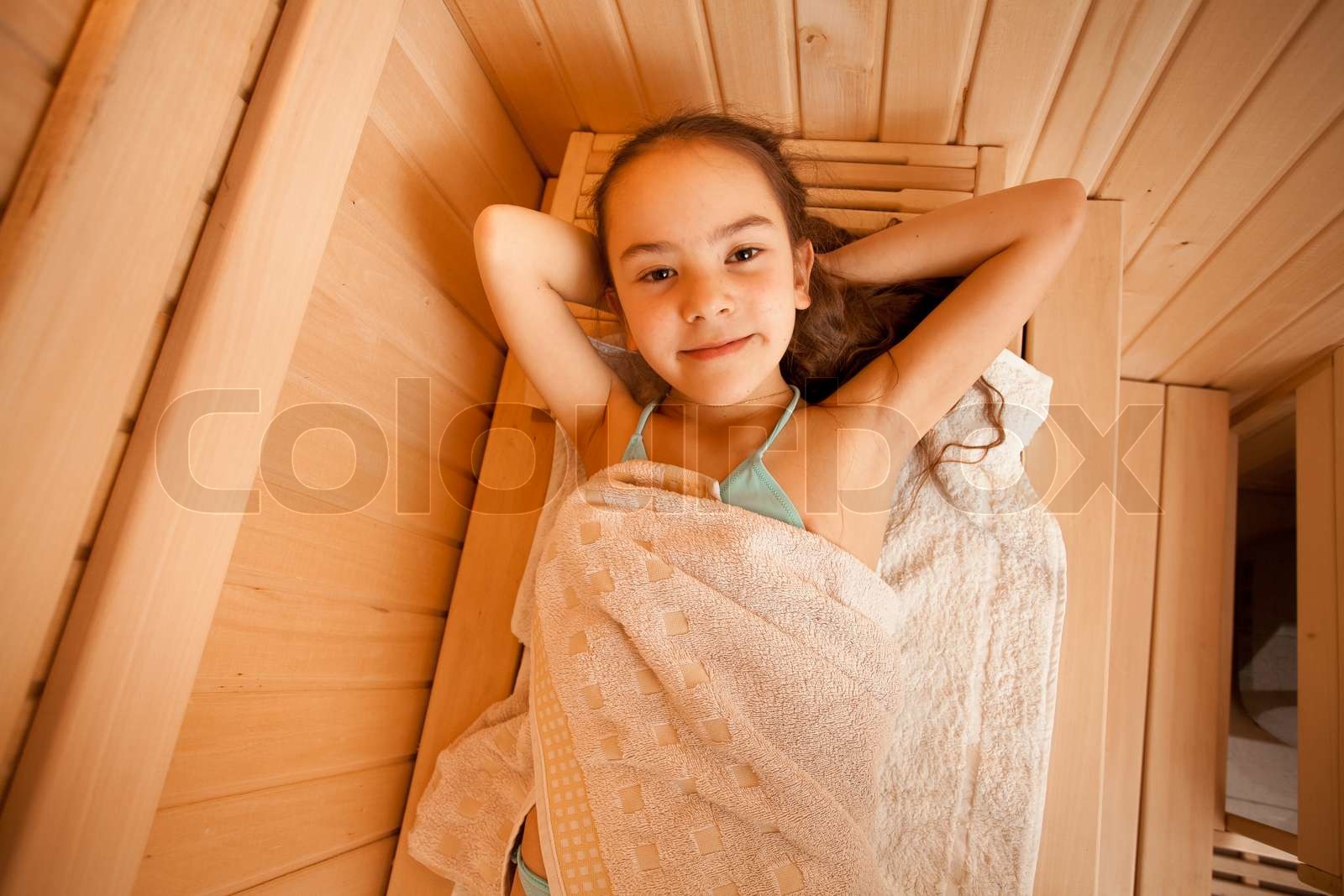 Portrait of little girl lying at sauna | Stock image | Colourbox