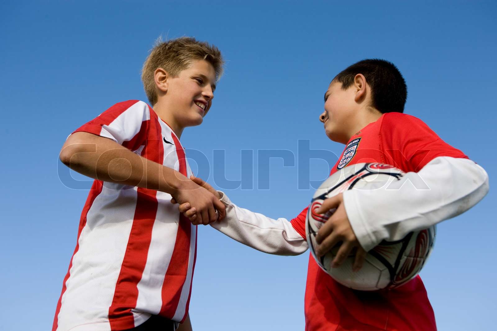 Two young football players shaking hands | Stock image | Colourbox