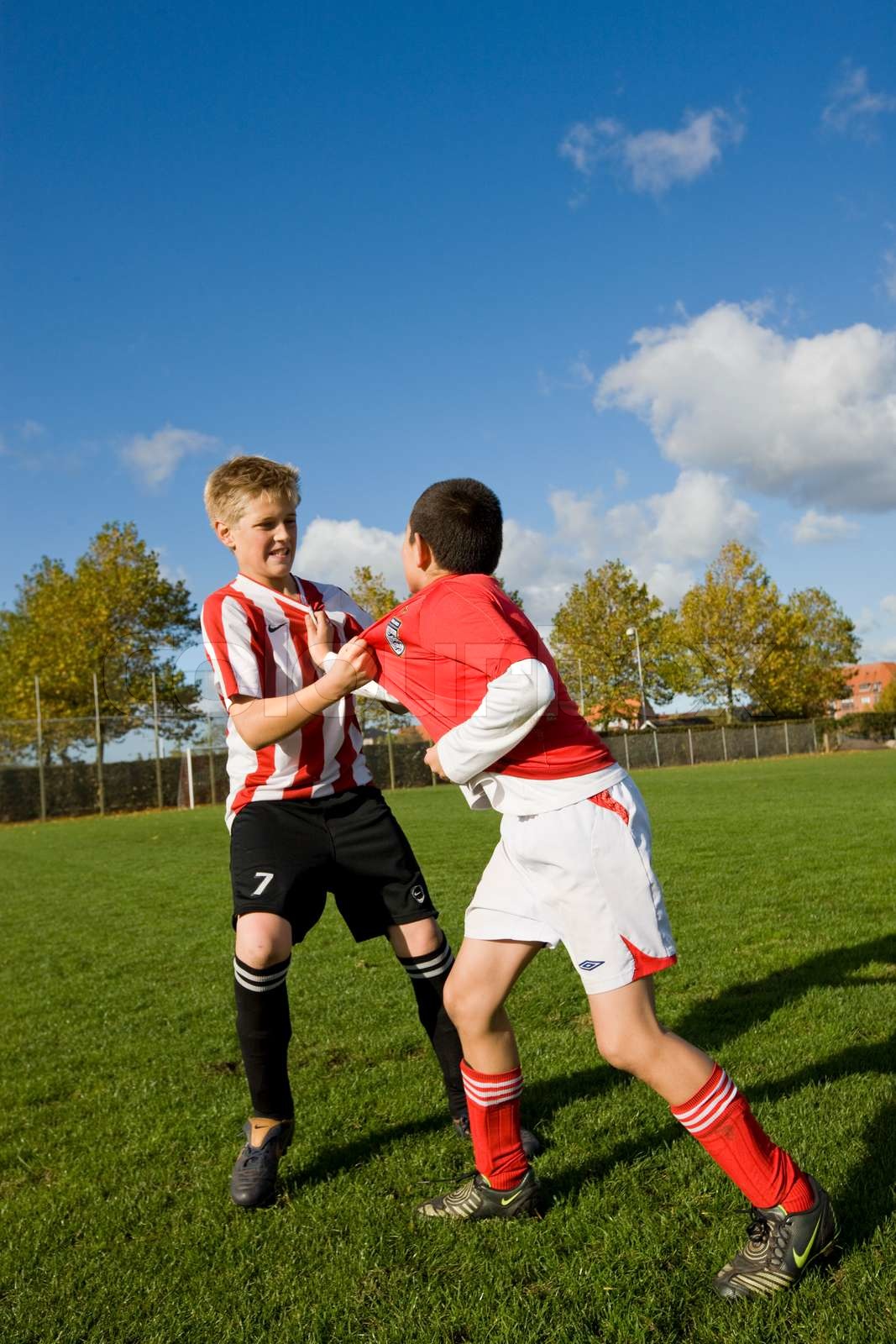 Two young football players fighting during their game | Stock image ...