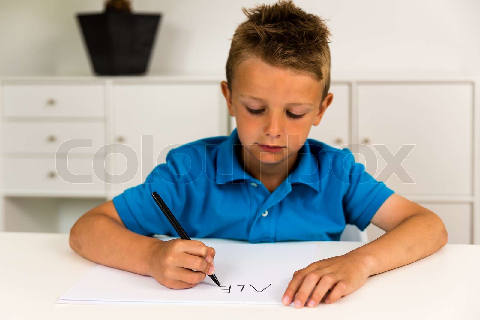 Boy writing the ABC alphabet | Stock image | Colourbox
