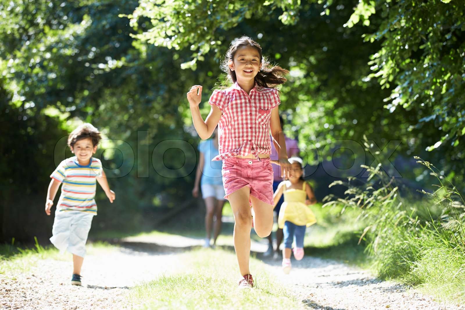 Asian Family Enjoying Walk In Countryside | Stock image | Colourbox