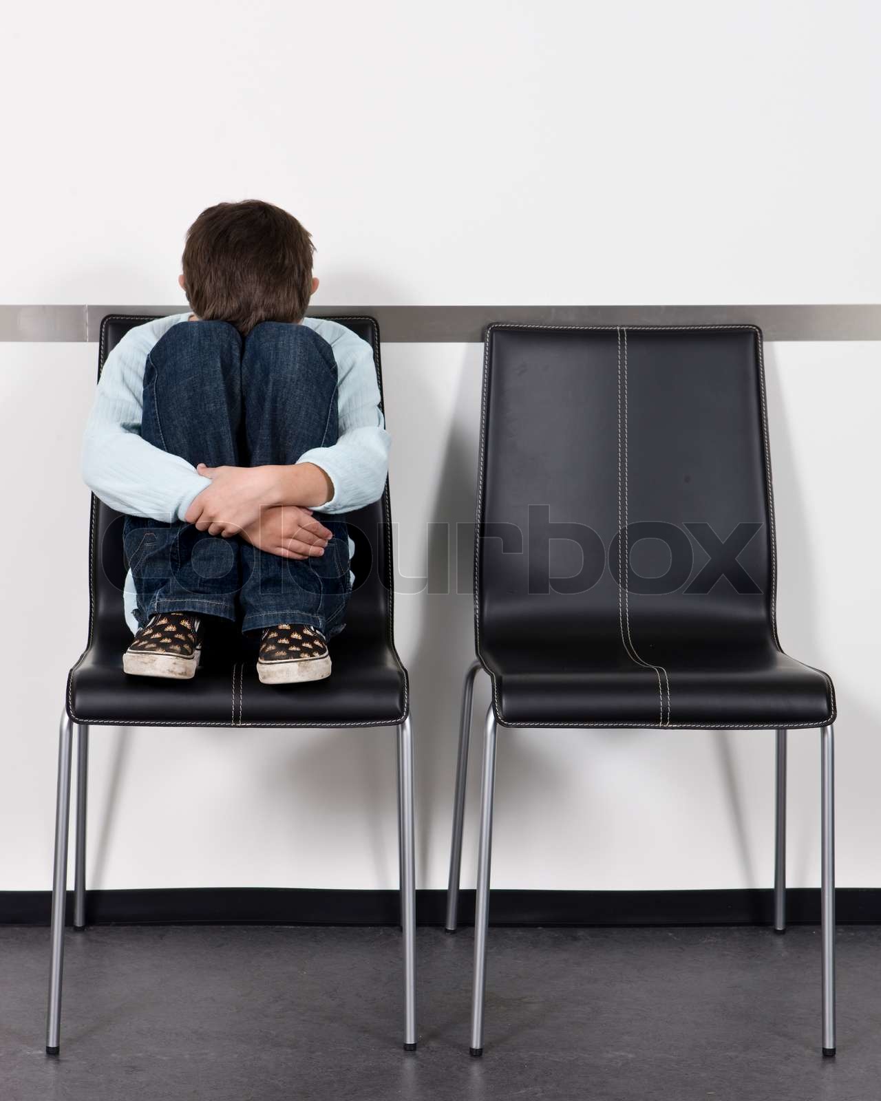 A depressed boy sitting on a chair | Stock image | Colourbox