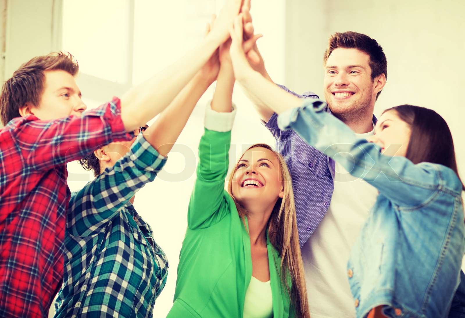 happy students giving high five at school | Stock image | Colourbox