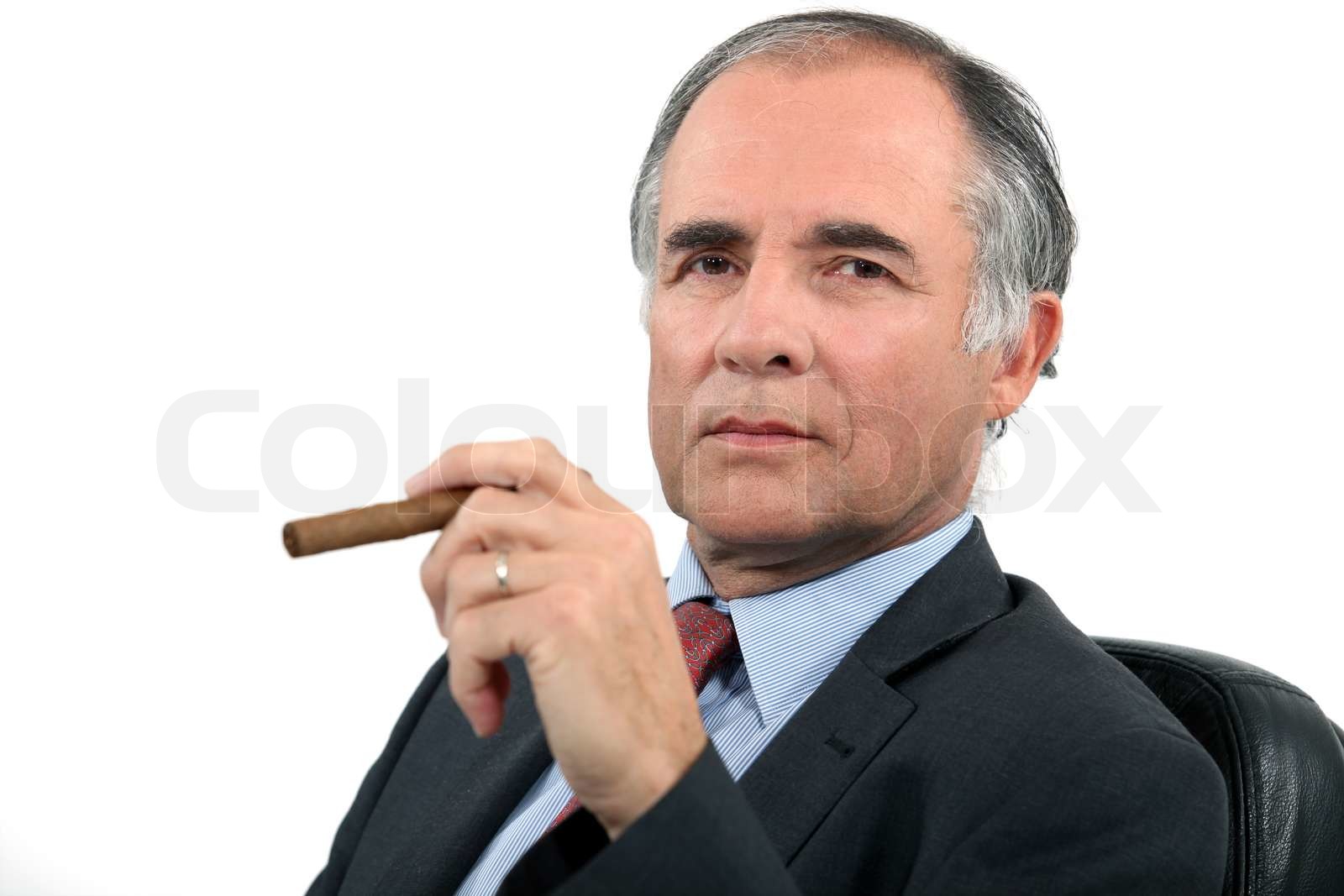 Businessman smoking cigar | Stock image | Colourbox