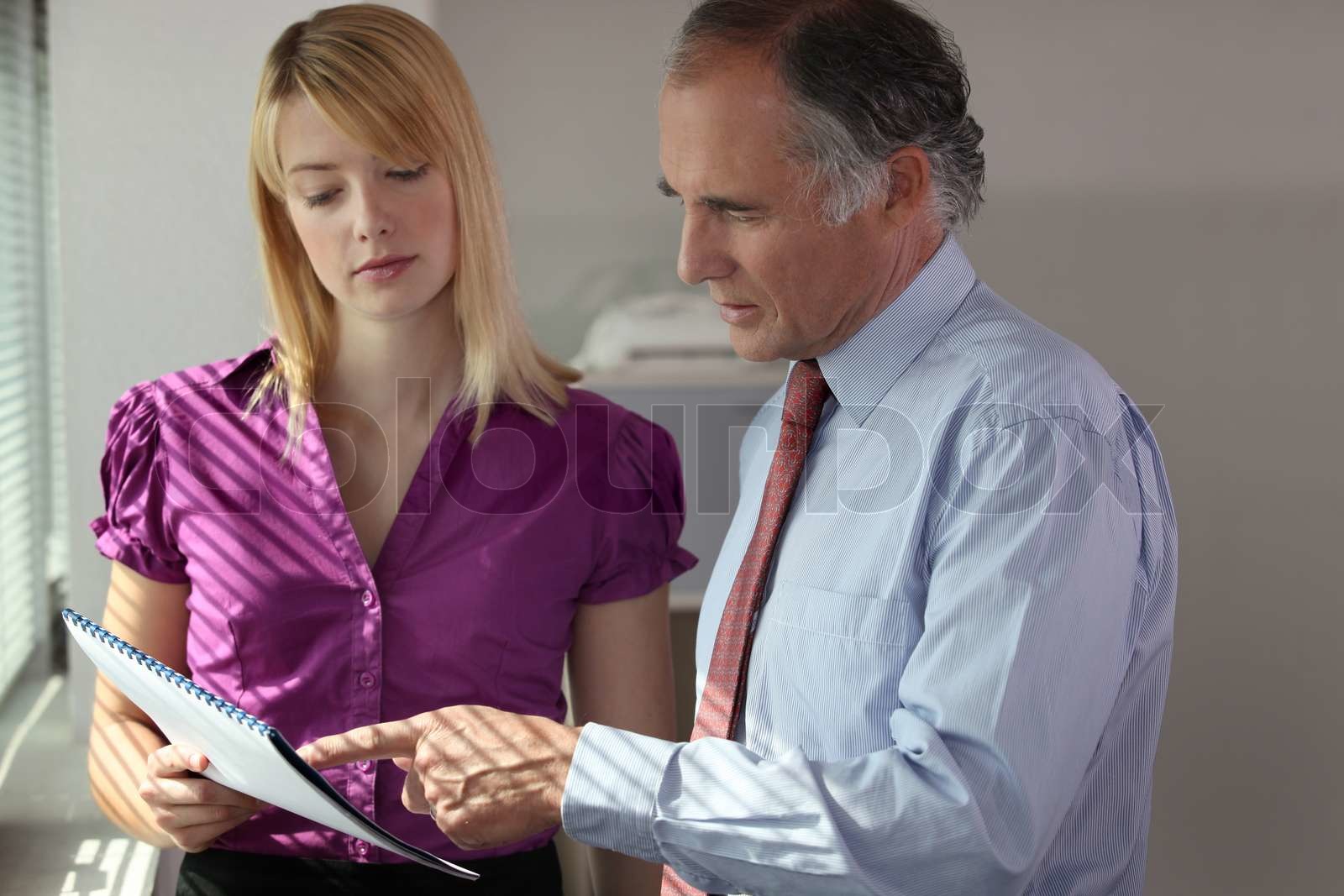 Boss handing out employee reviews | Stock image | Colourbox
