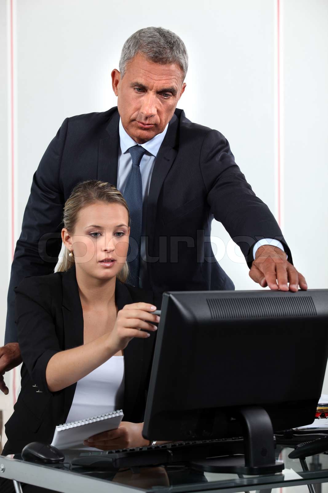 Personal assistant asking her boss a question | Stock image | Colourbox