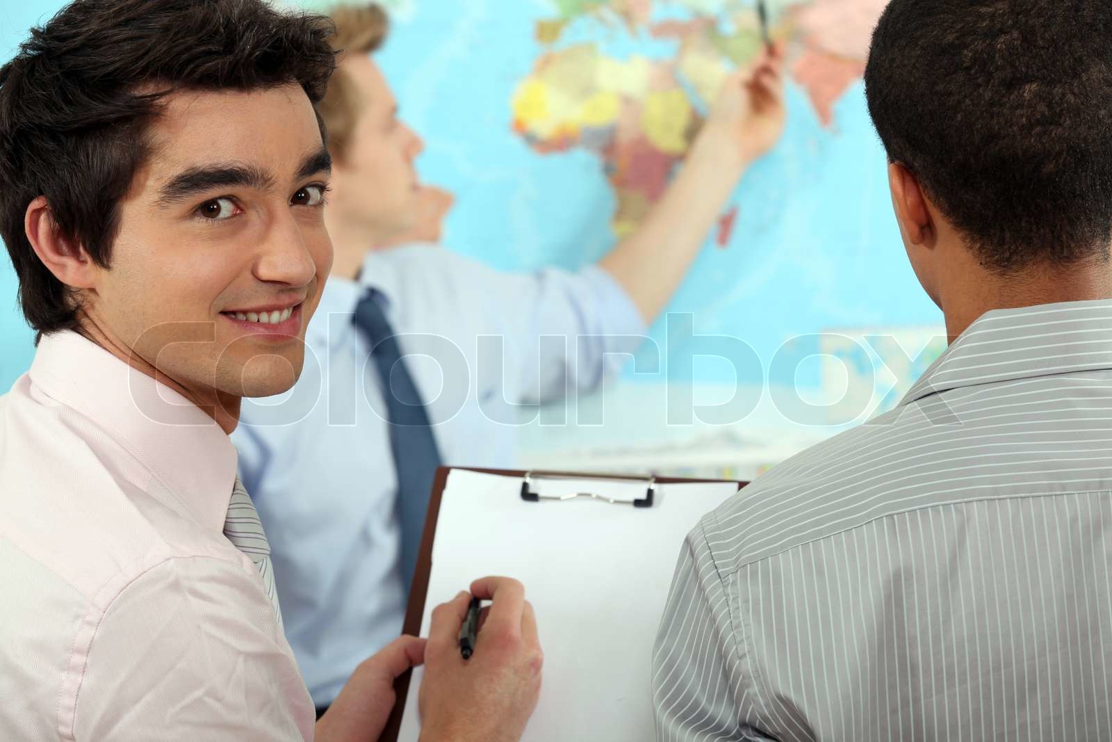 Young businessman discussing a map | Stock image | Colourbox