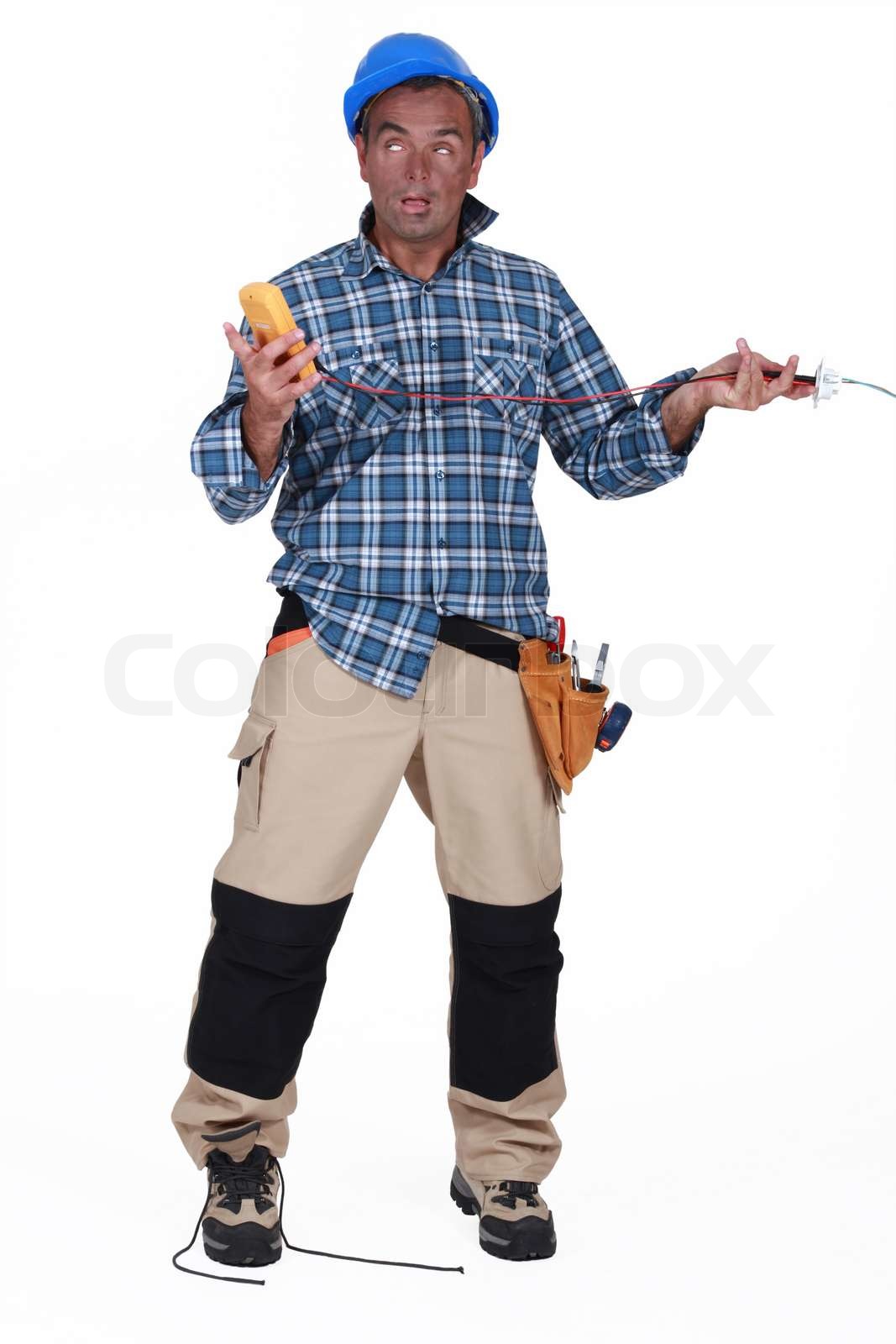 An electrocuted man holding a multitester | Stock image | Colourbox