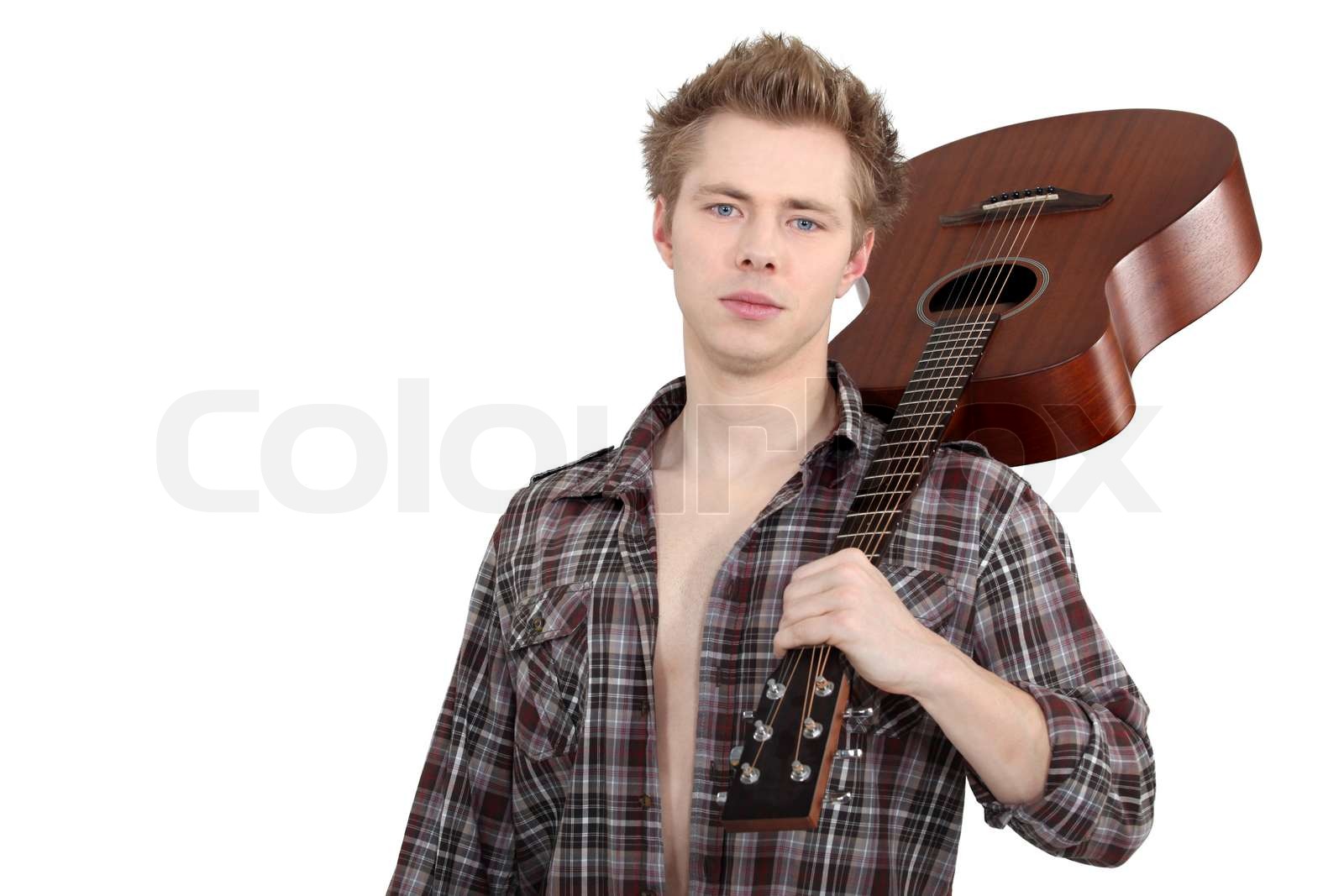 Man holding an acoustic guitar | Stock image | Colourbox