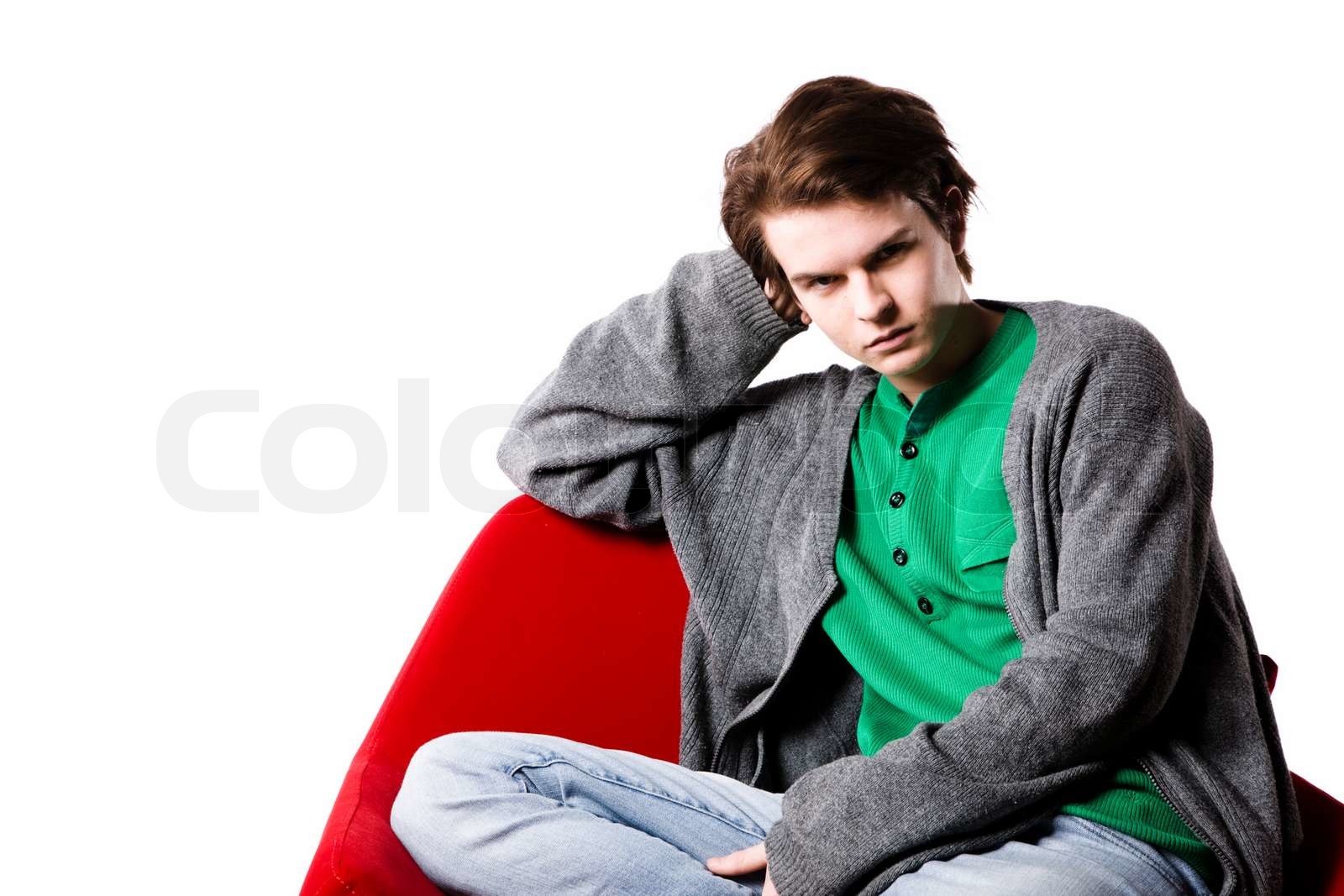 A teenage boy slouching on a couch | Stock image | Colourbox