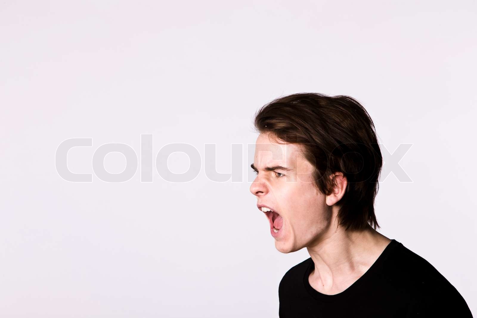 A teenage boy screaming out loud | Stock image | Colourbox