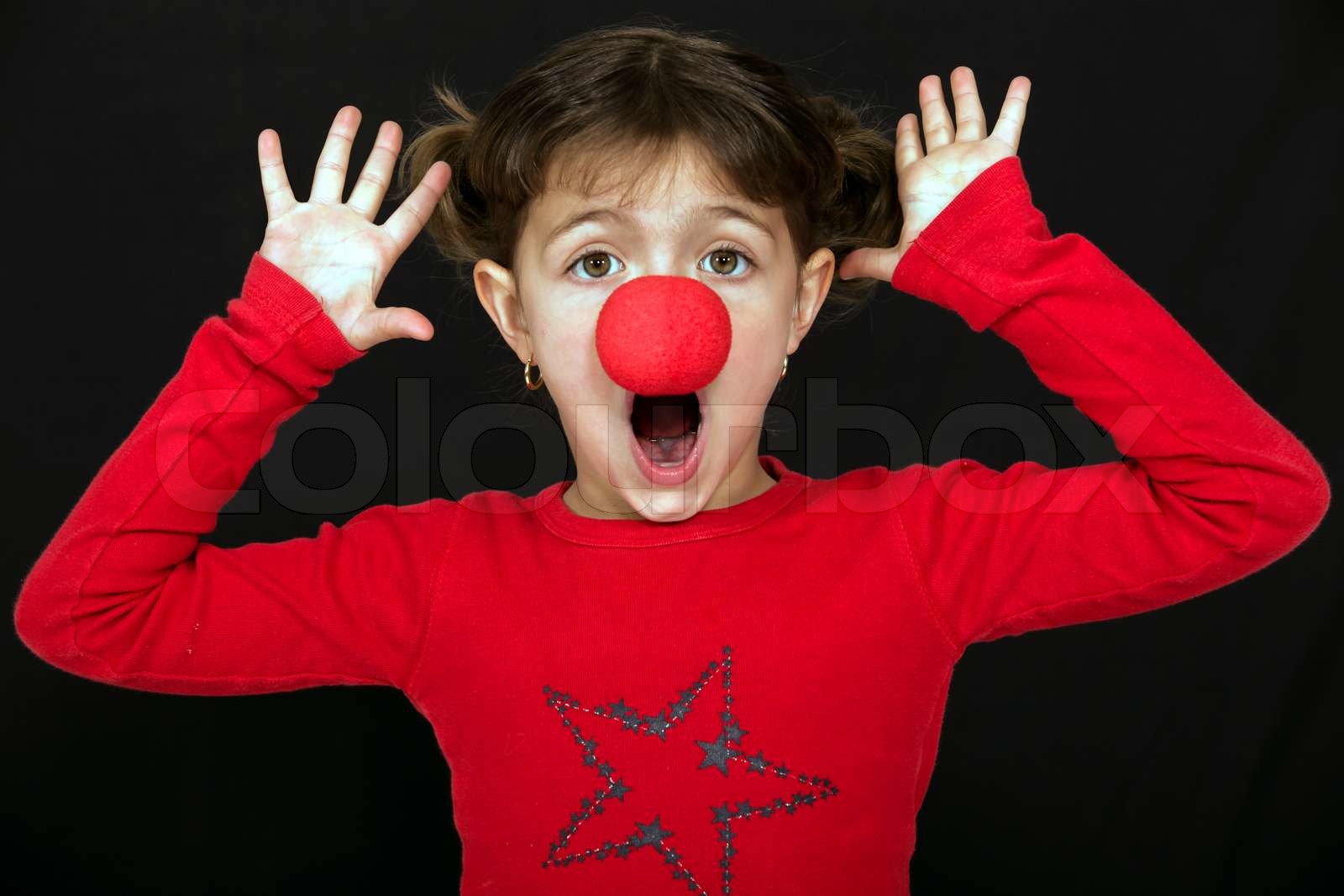 Little girl surprised with a clown nose | Stock image | Colourbox