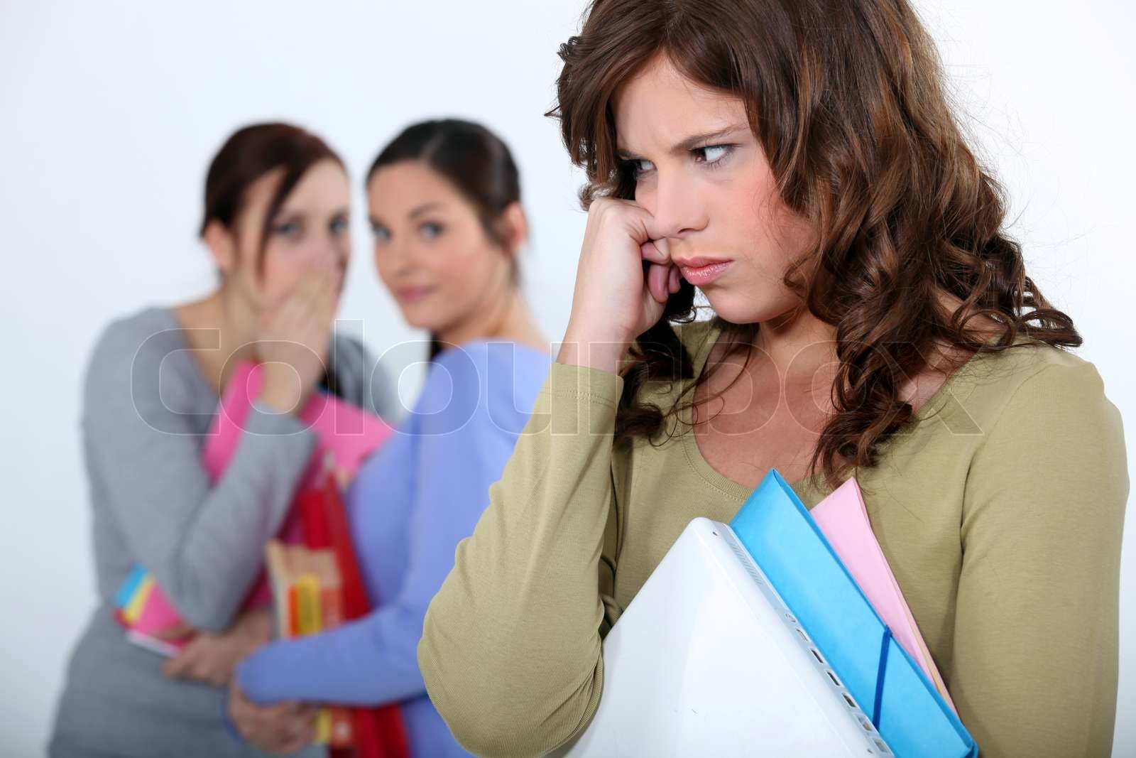 Girls criticizing another girl | Stock image | Colourbox