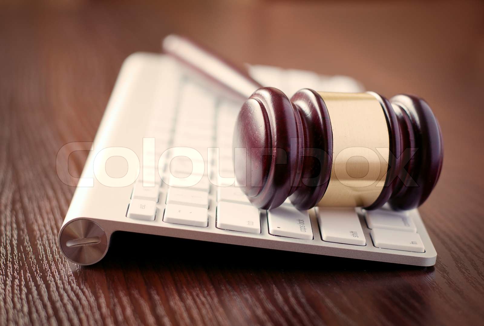 Wooden judges gavel on a computer keyboard | Stock image | Colourbox