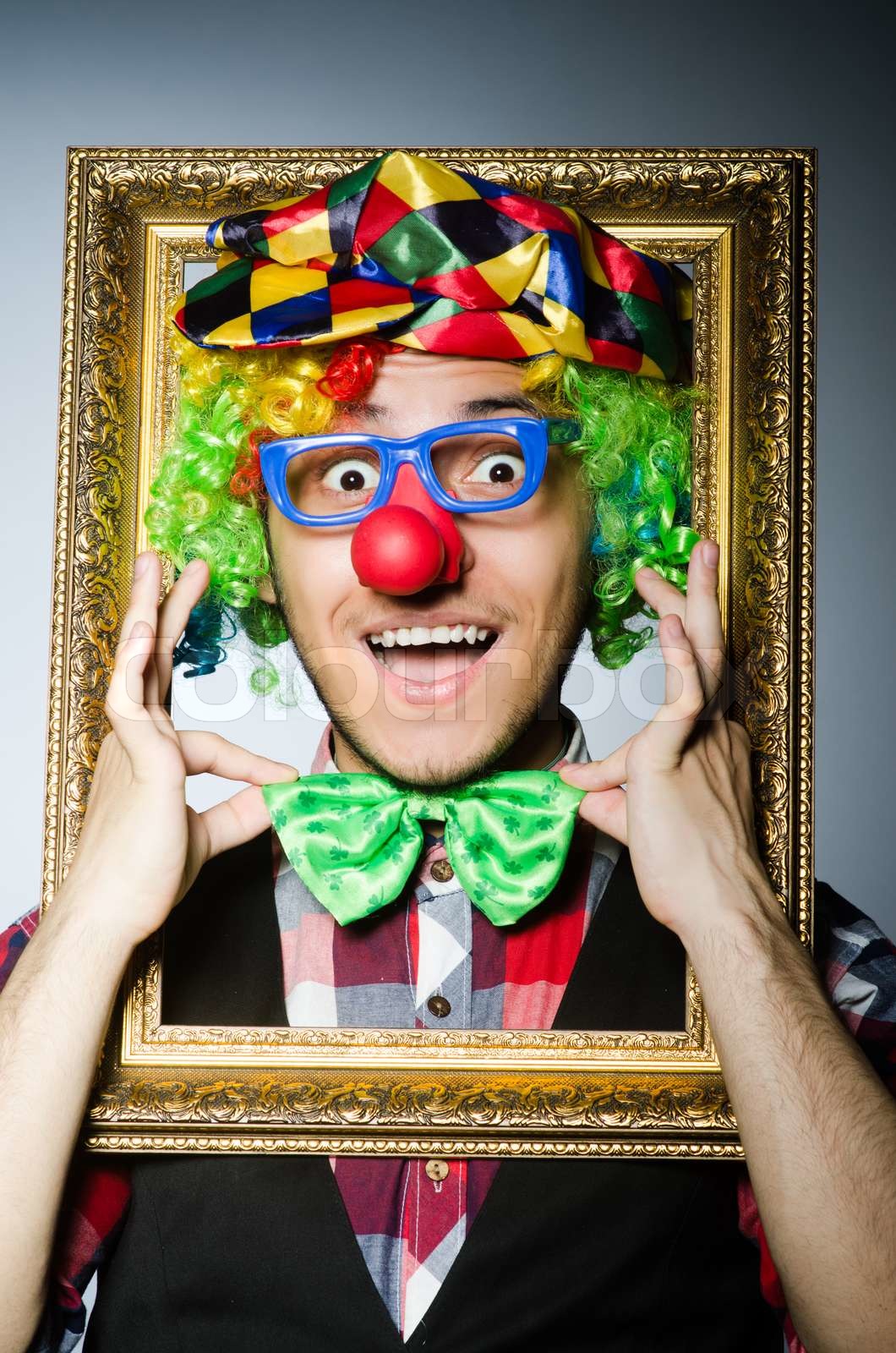 Funny clown with picture frame | Stock image | Colourbox