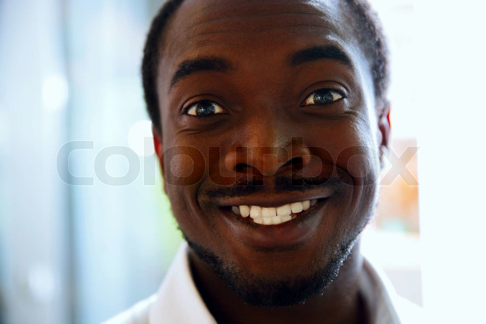 Closeup portrait of a happy black man | Stock image | Colourbox