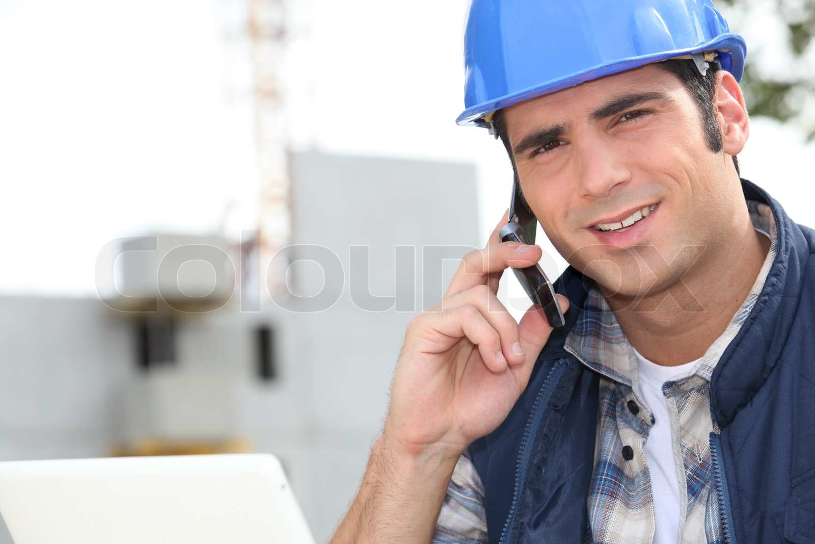 Construction worker using a mobile phone | Stock image | Colourbox
