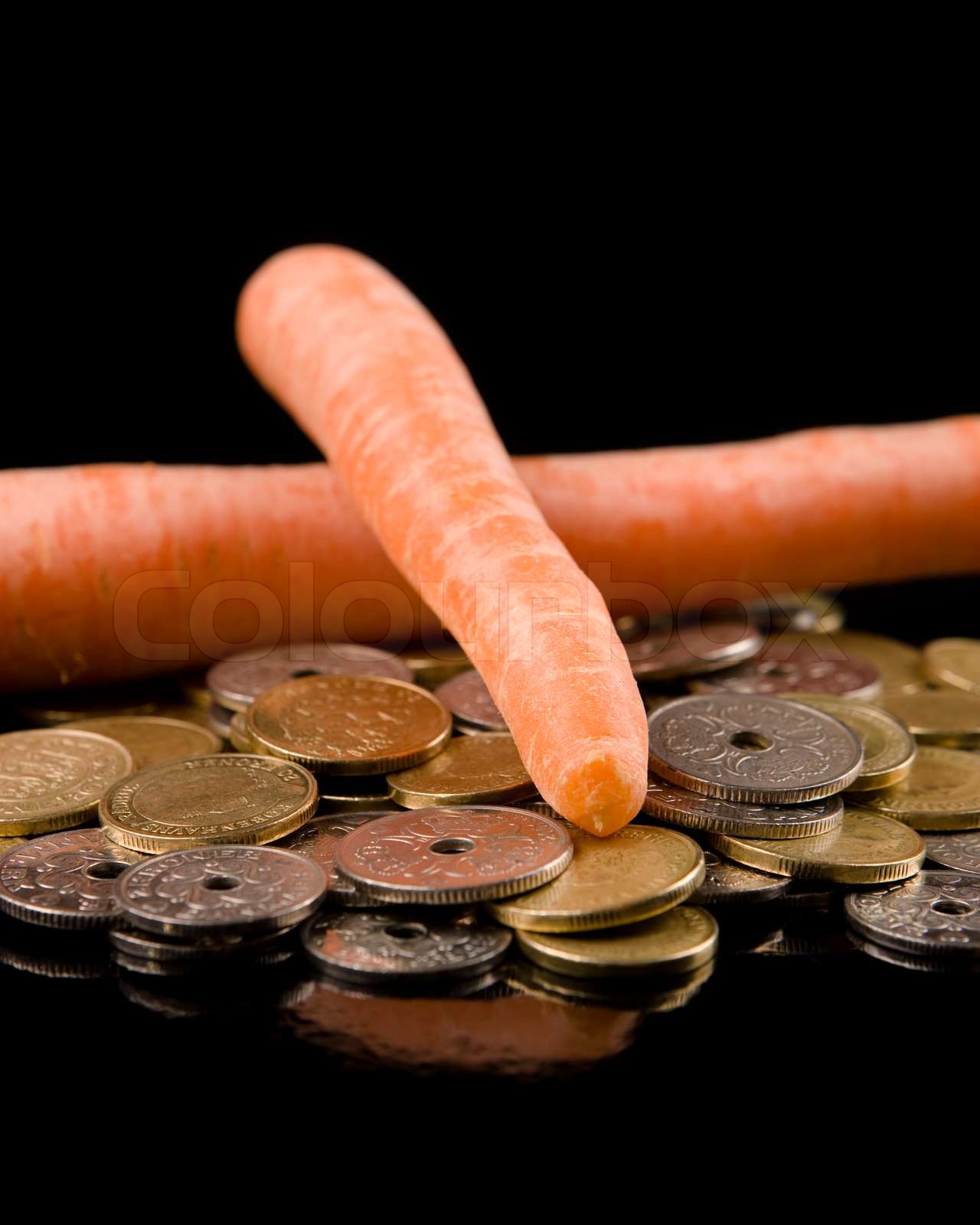 Carrots on coins | Stock image | Colourbox