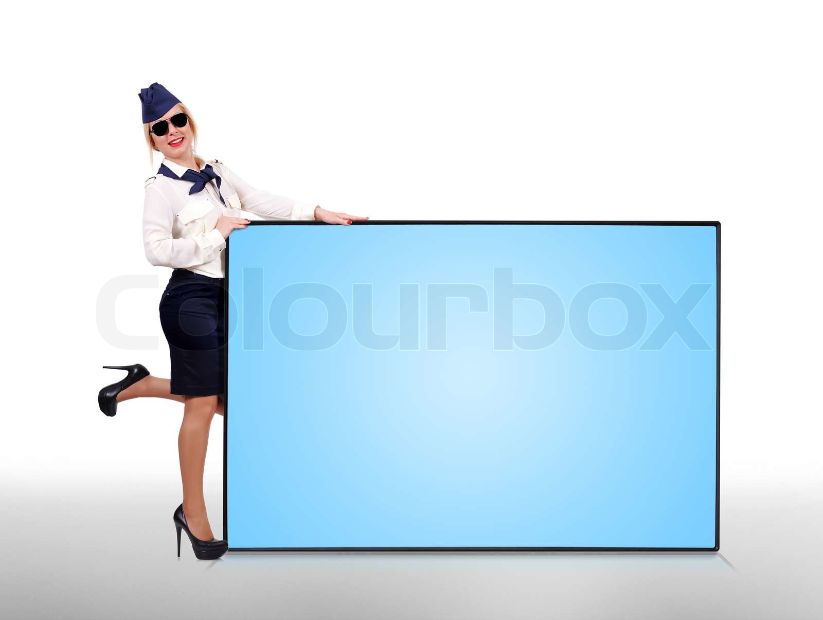 Flight attendant holding big panel | Stock image | Colourbox