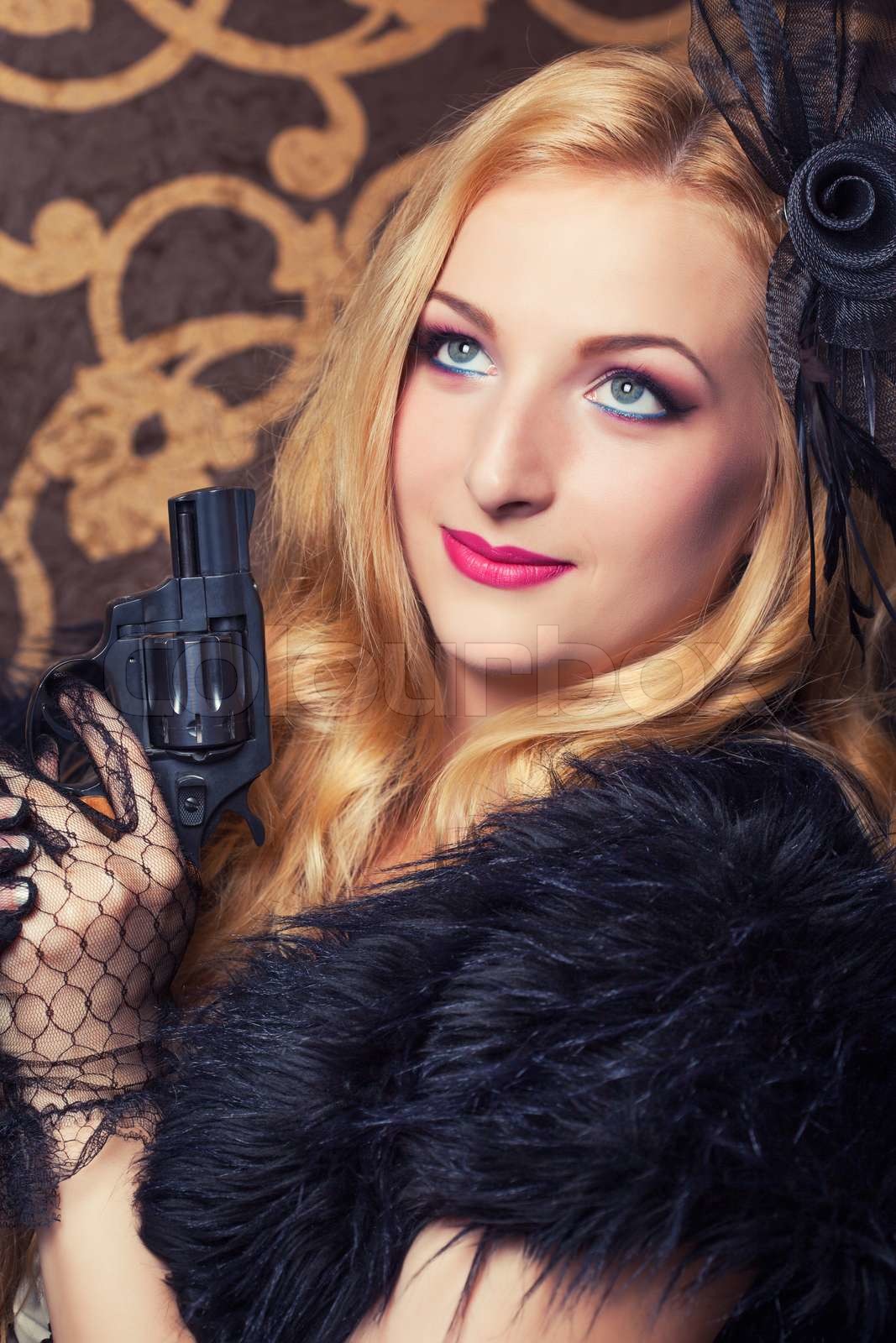 beautiful retro woman holding a revolver | Stock image | Colourbox