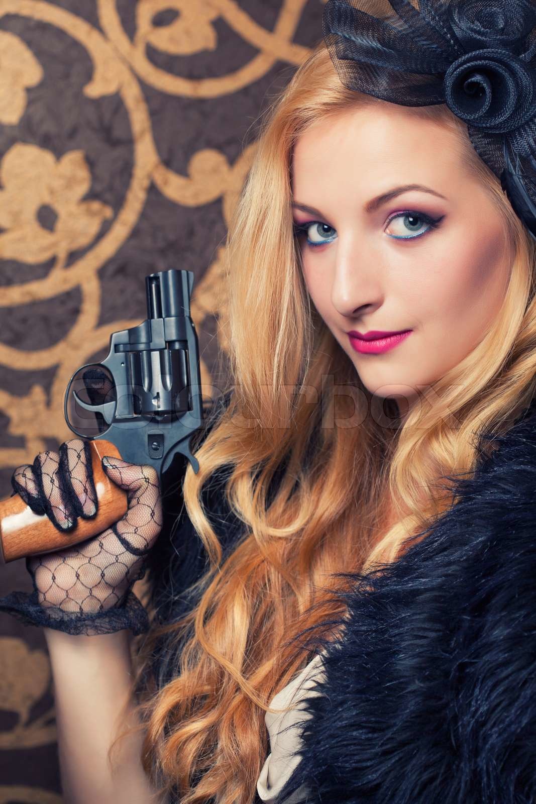 beautiful retro woman holding a revolver | Stock image | Colourbox