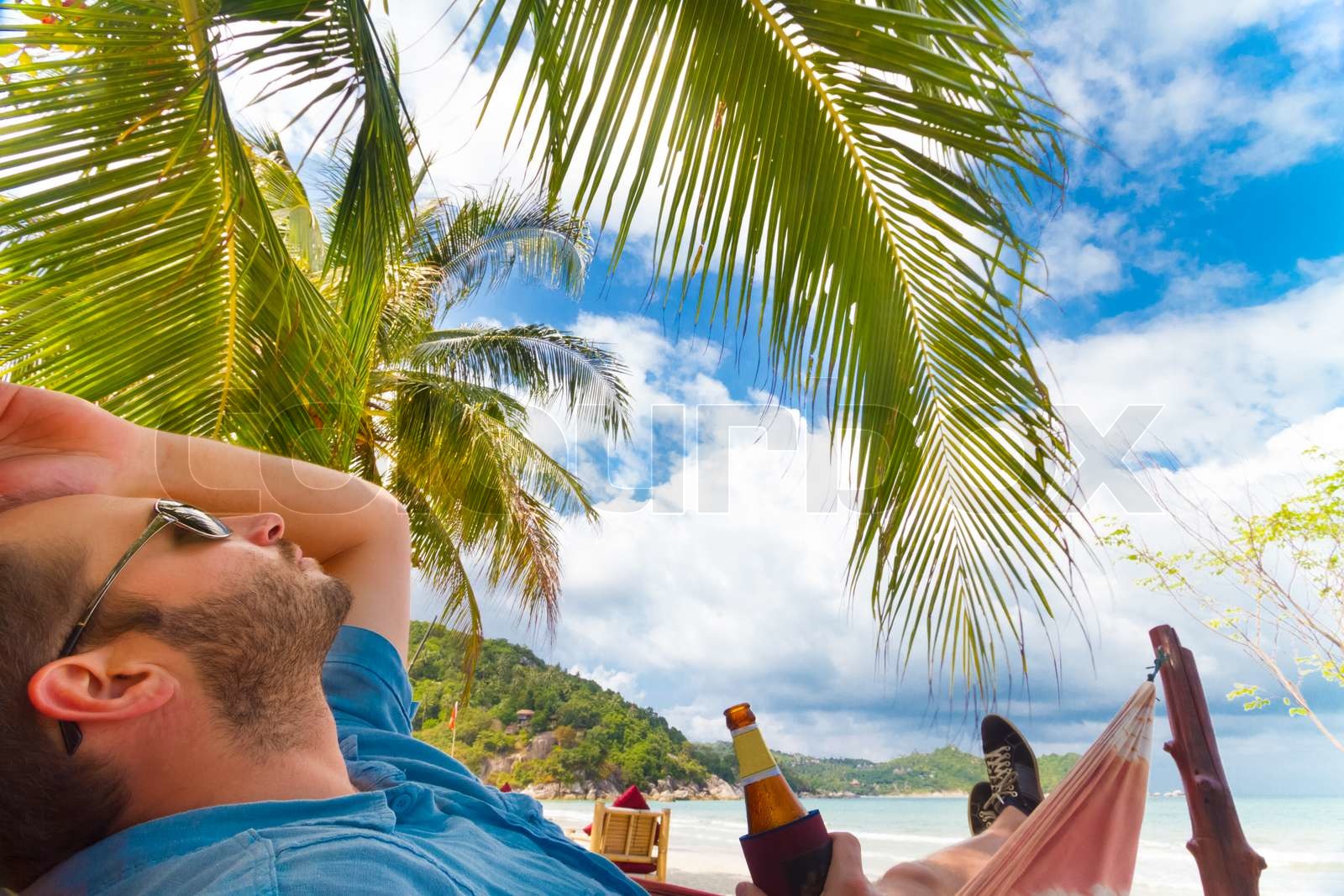 Man relaxing on a tropical beach. | Stock image | Colourbox