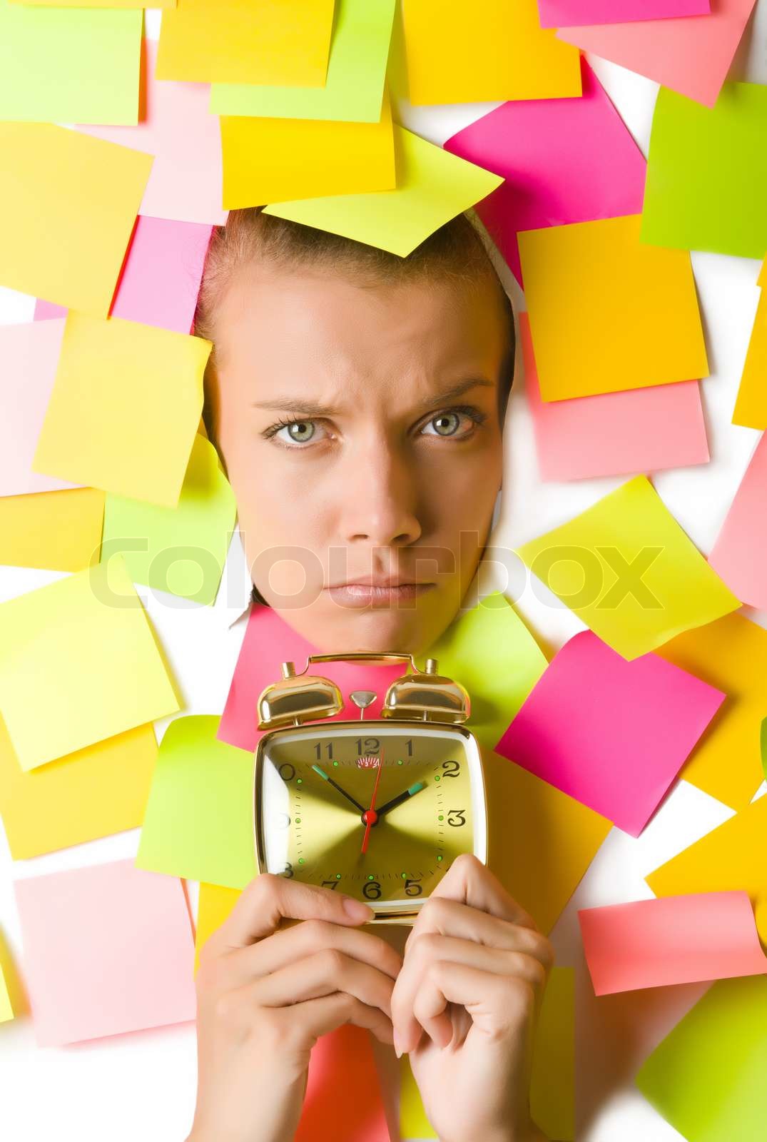 Woman with clock and lots of reminders | Stock image | Colourbox